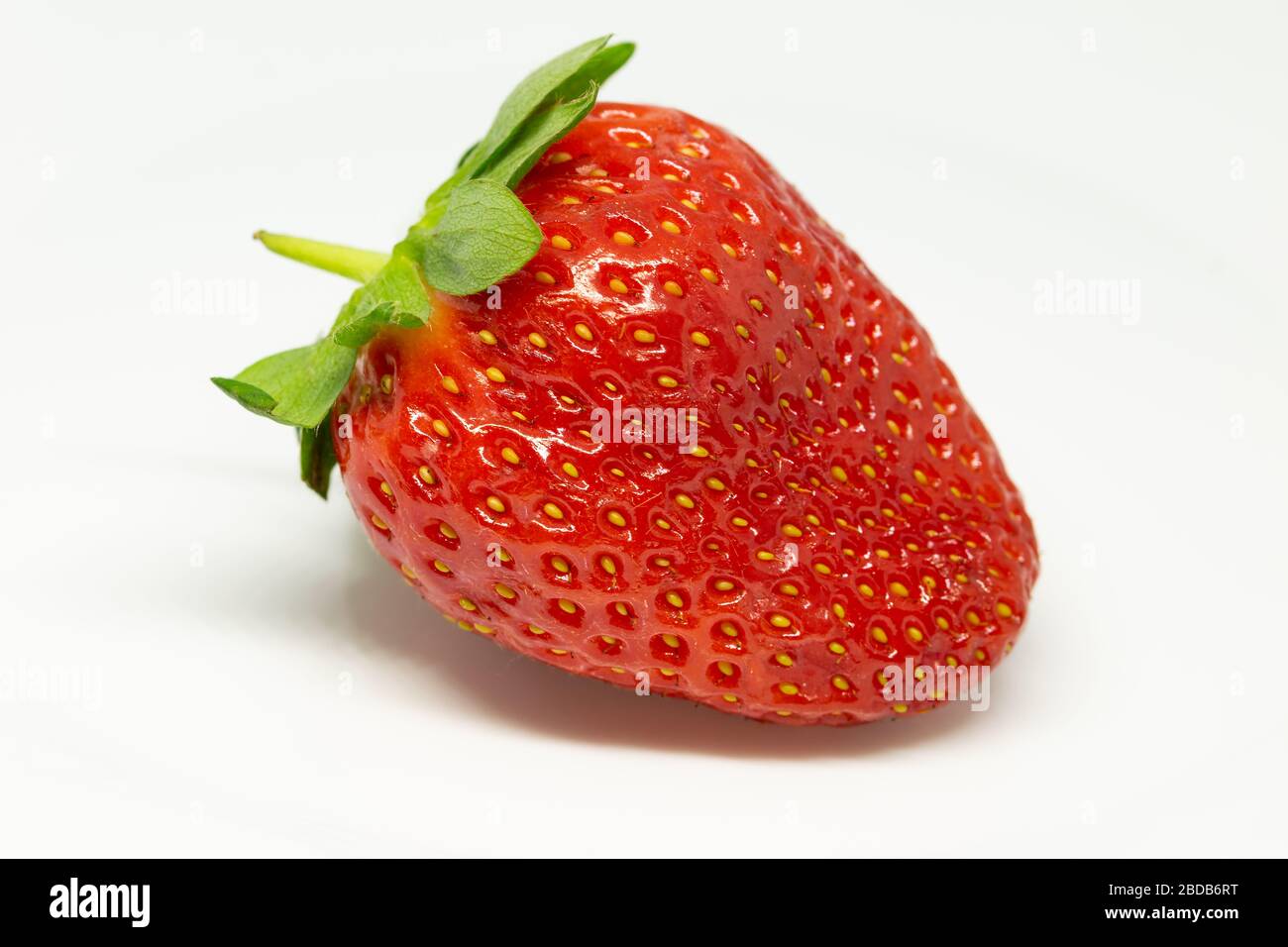 Strawberry in close-up. Red, ripe fruit on a white background. Spring ...