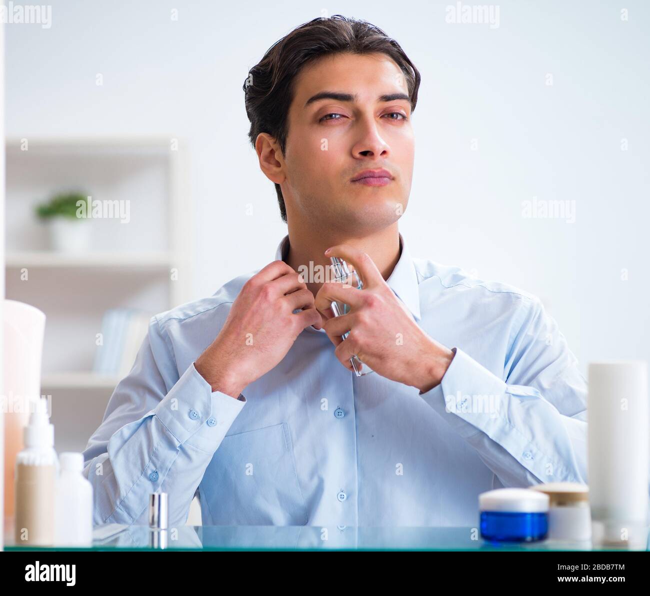 The man is getting dressed up for work in bathroom Stock Photo - Alamy