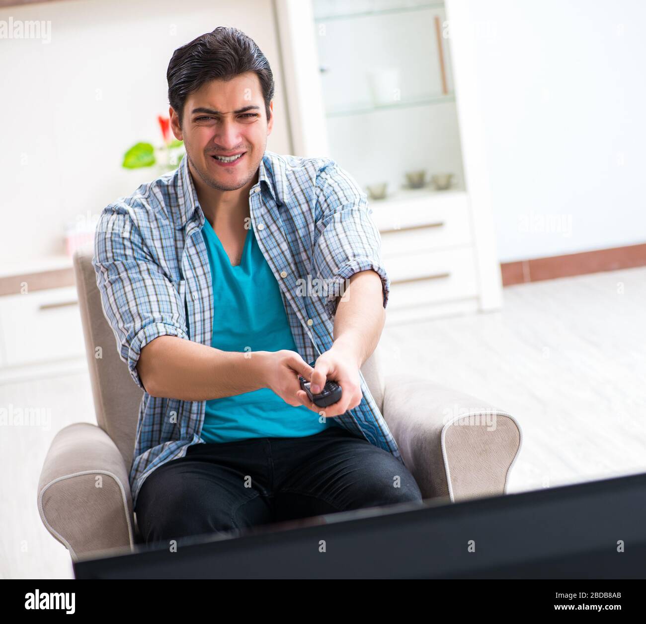 The man watching tv at home Stock Photo - Alamy