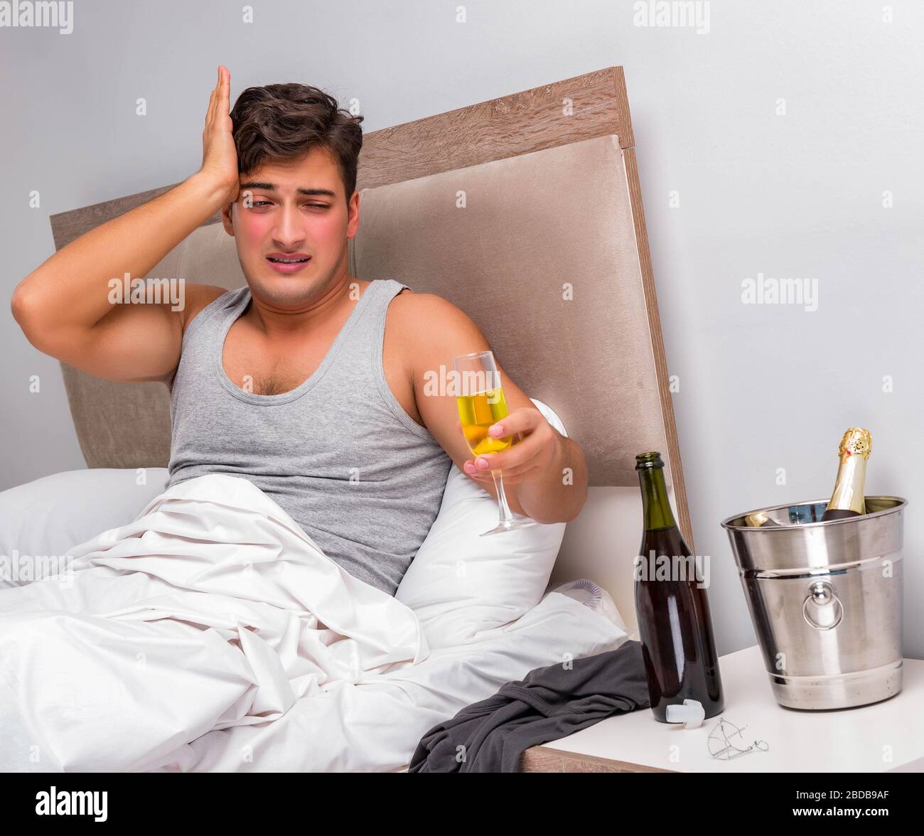 The man in the bed after party - hangover concept Stock Photo - Alamy
