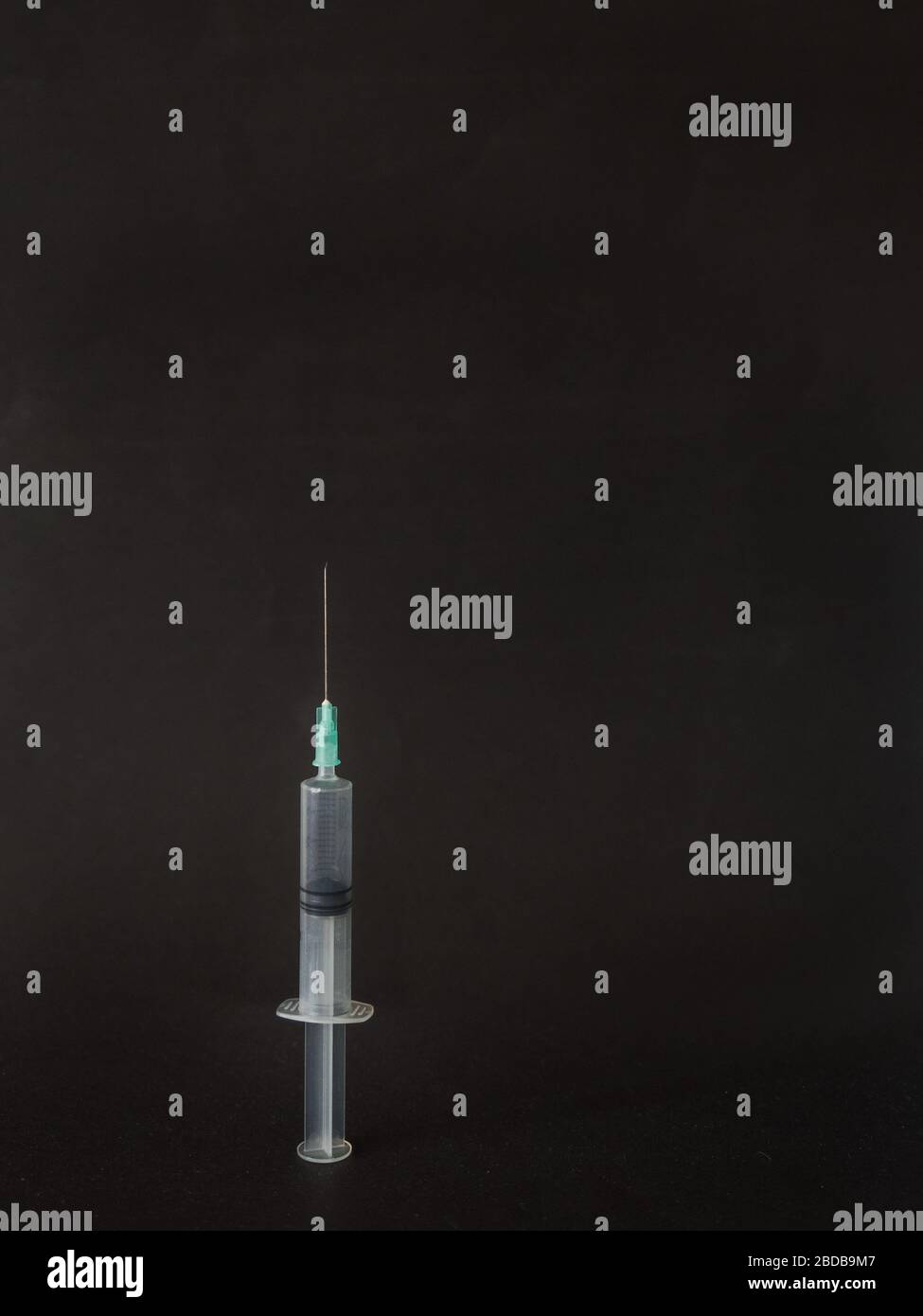 Syringe on black background with copy space Stock Photo - Alamy