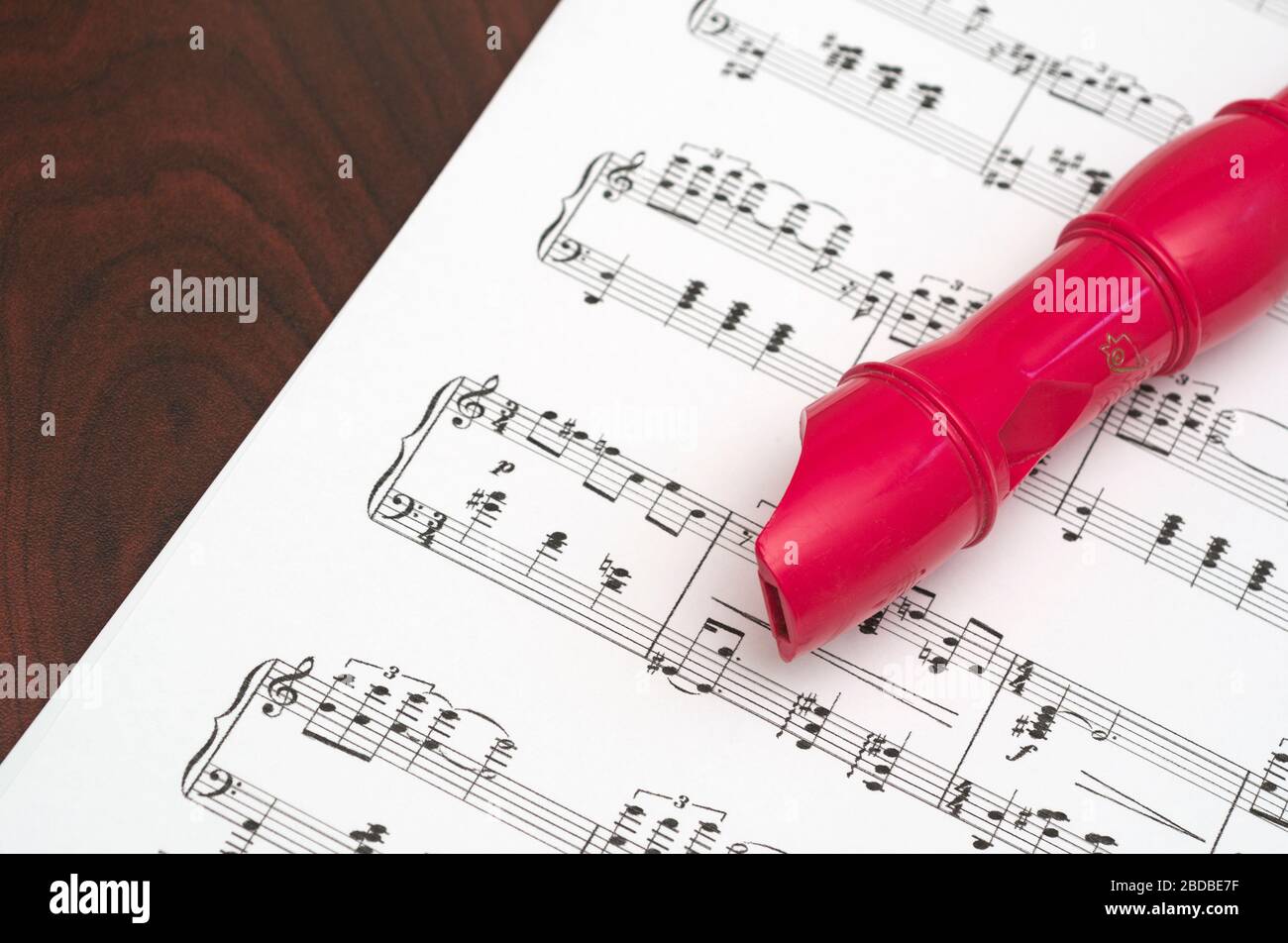 plastic flute on a sheet of music Stock Photo - Alamy