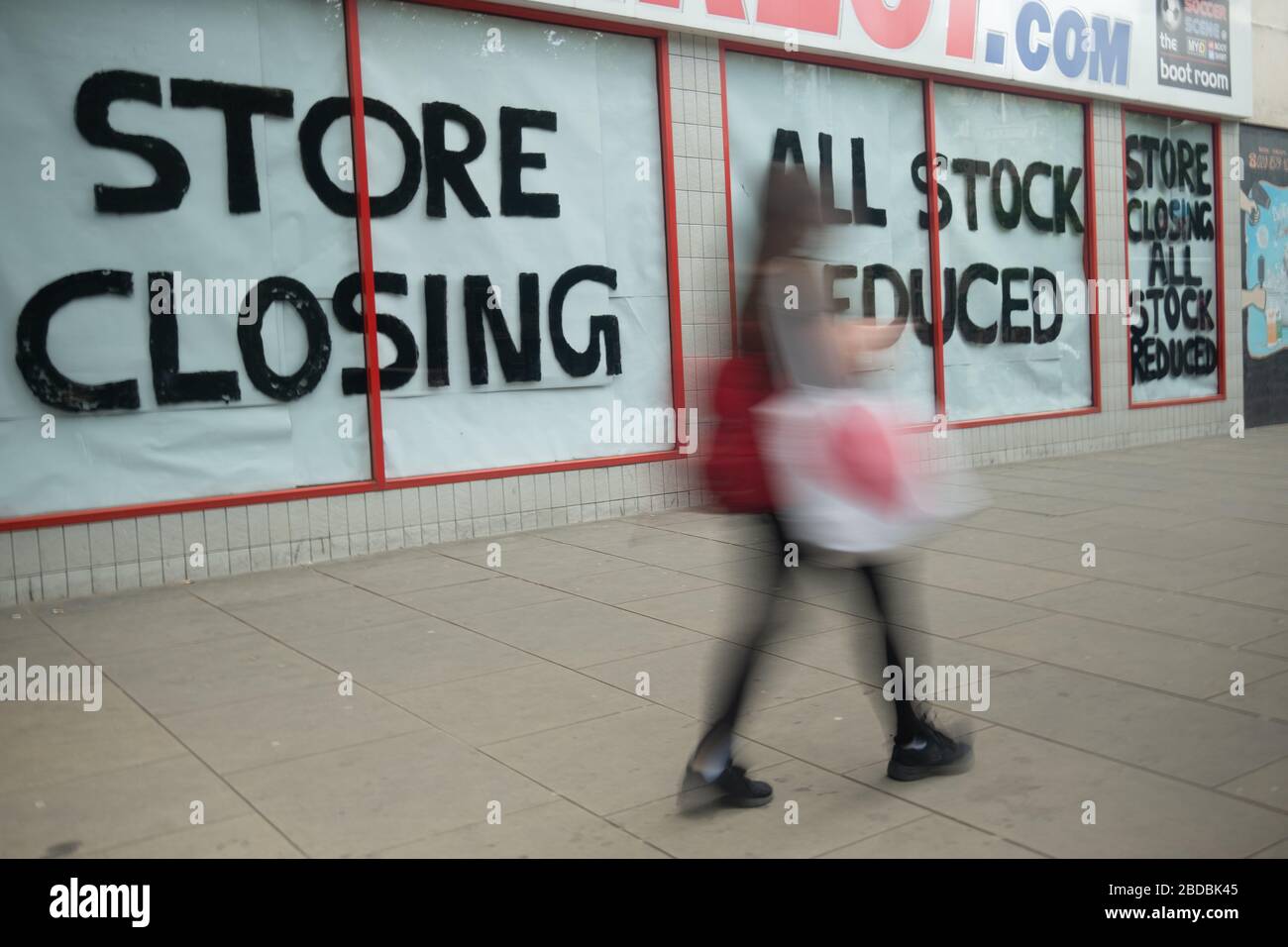 High Street shop with 'store closing' signage and motion blurred ...