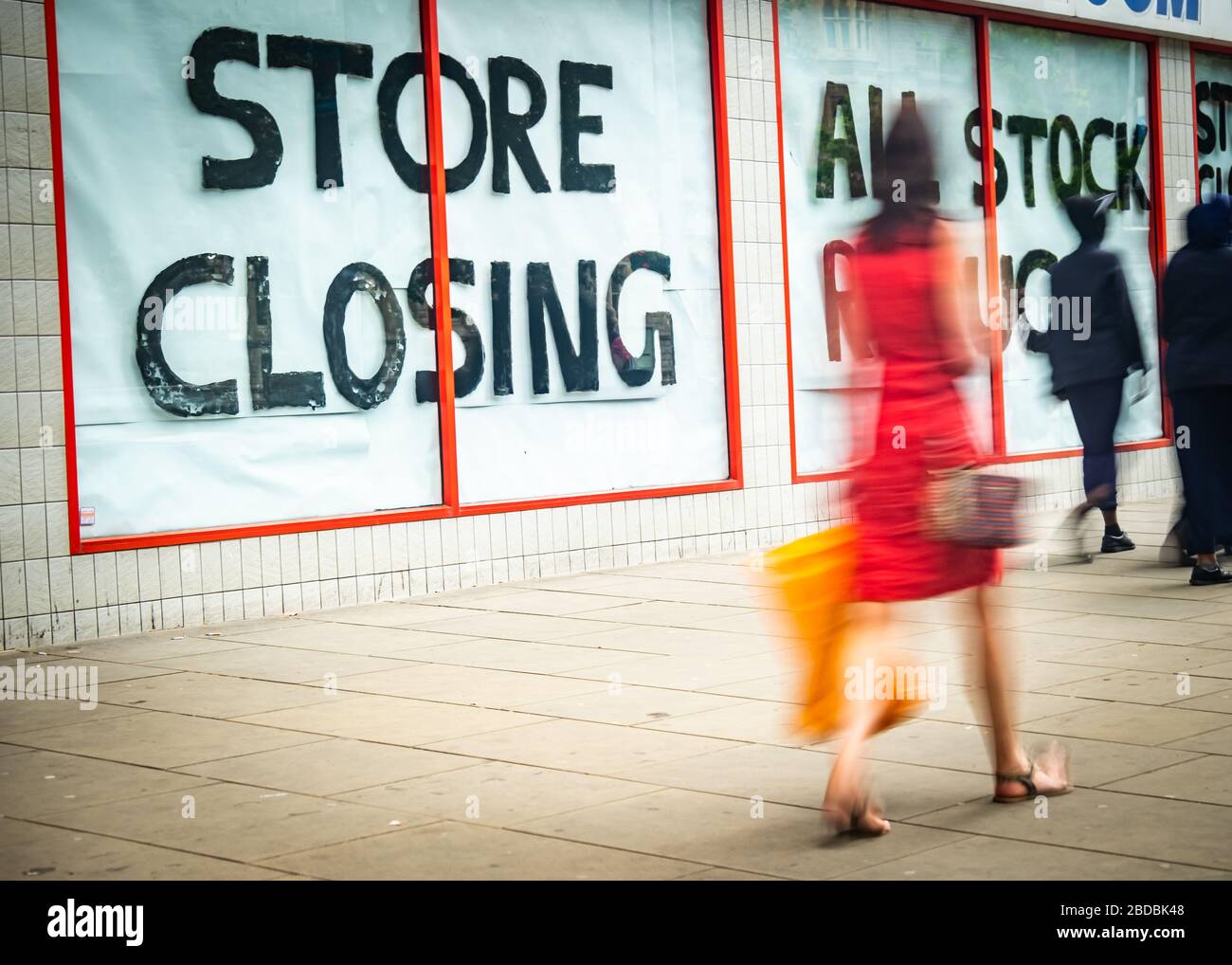High Street shop with 'store closing' signage and motion blurred ...