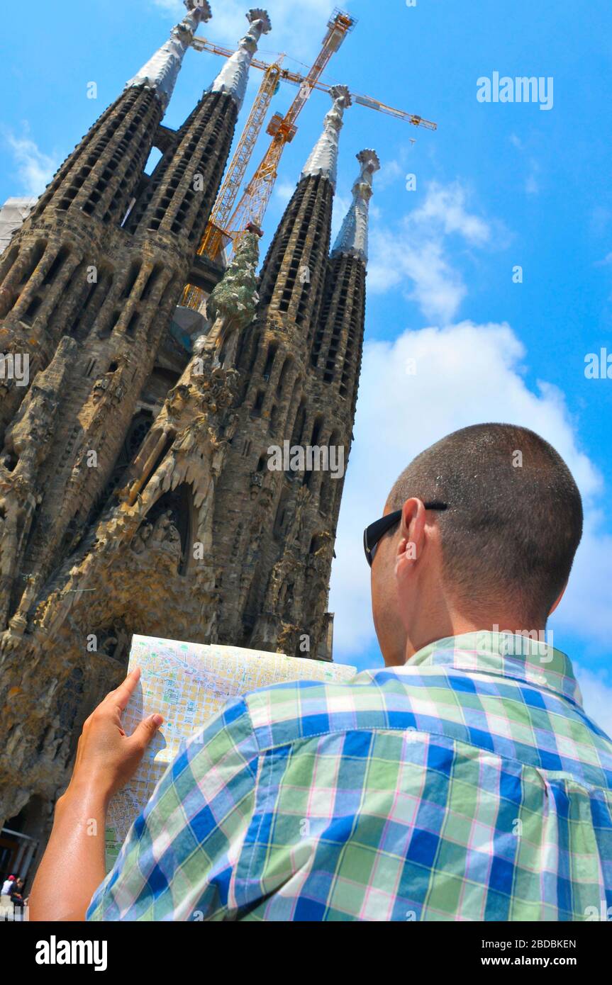 BARCELONA, SPAIN - JULY 14: Tourist with a city map in front of La ...