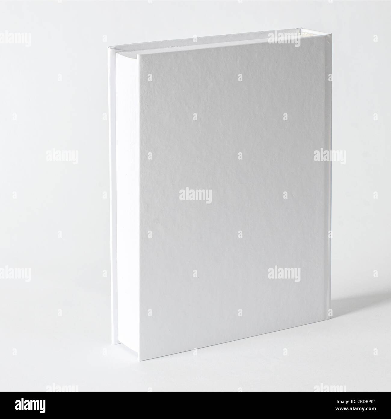 Mockup of closed blank square book at white textured paper background ...