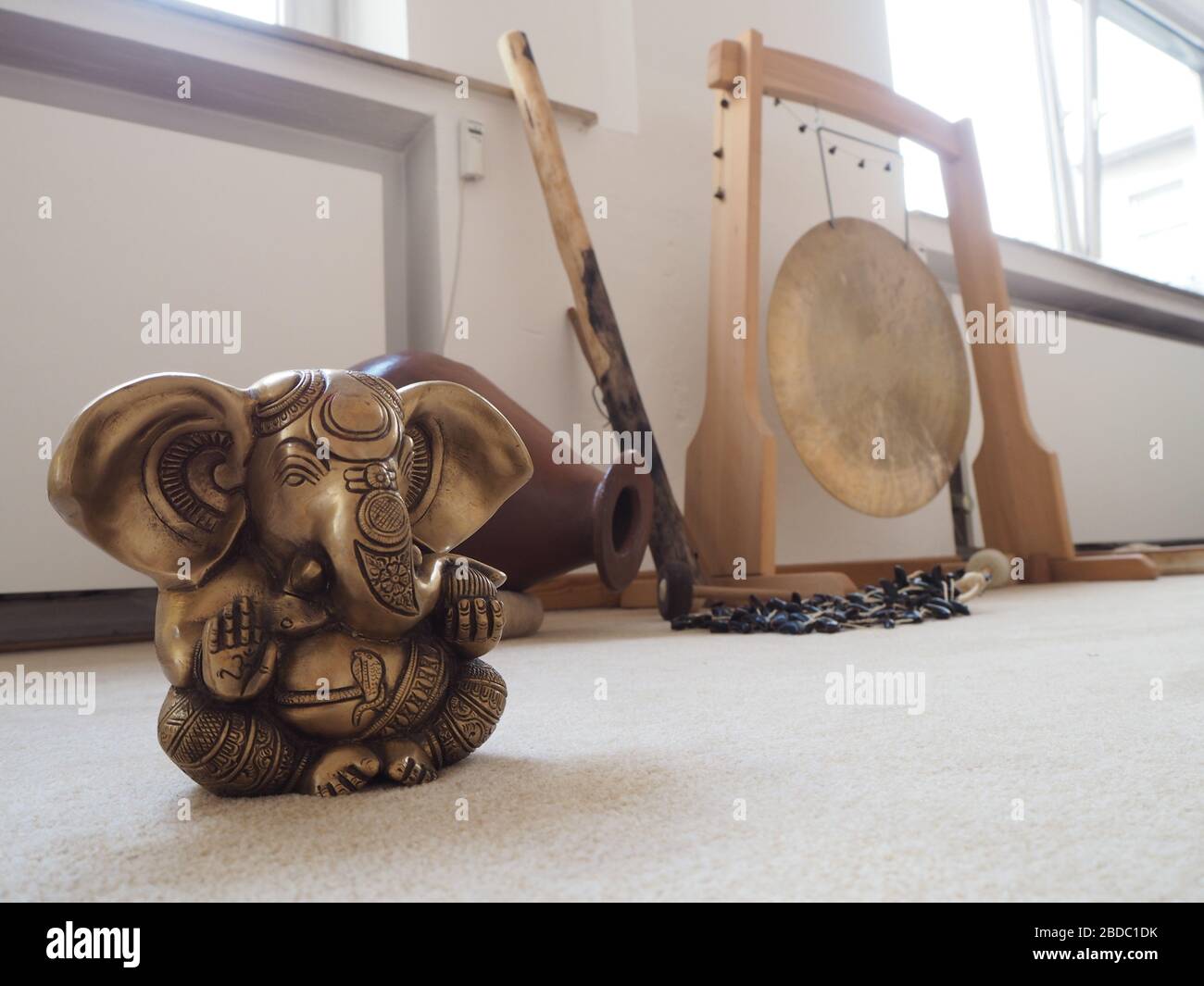 Close up of hindu god Ganesha with an instrument set up for a sound ...