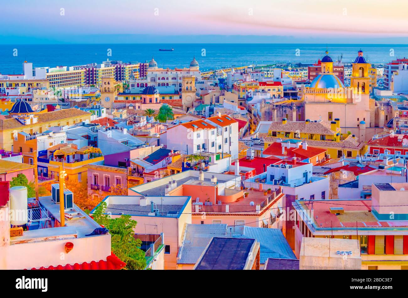 Alicante cityscape at dusk, showing the cathedral with the sea in the ...