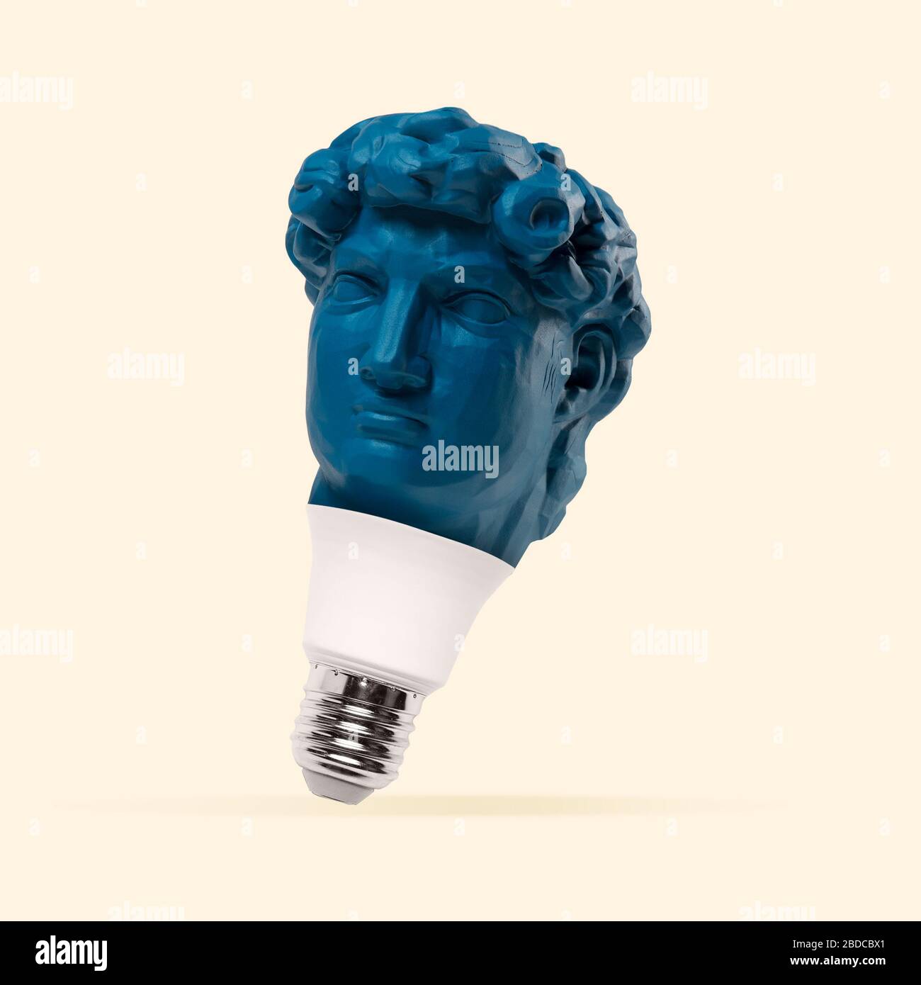 White lightbulb made of blue statue head on pink background. Negative ...