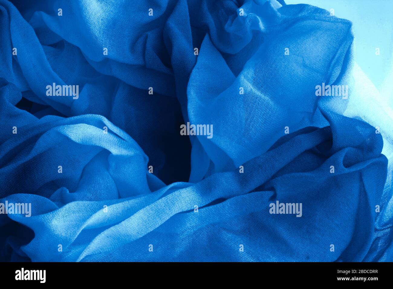 Texture of classic blue Wrinkled Fabric. Trendy color of clothes. Close ...