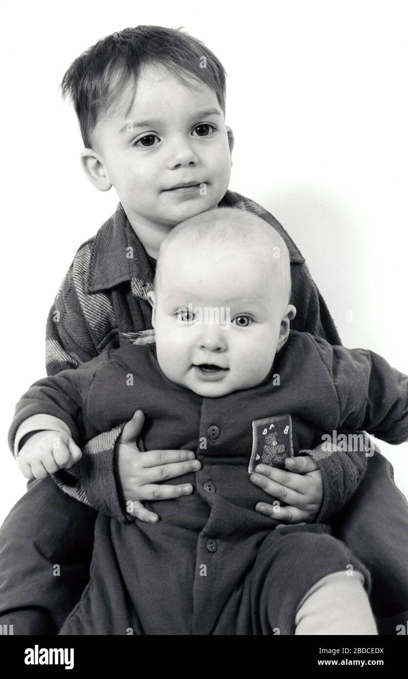 Studio portrait of small boy & baby UK 1990s Stock Photo - Alamy