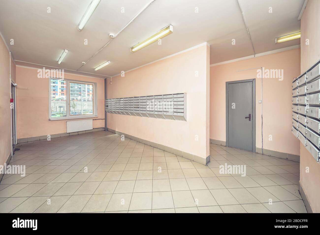 Empty hall mailboxes and doors at new apartment building Stock Photo ...