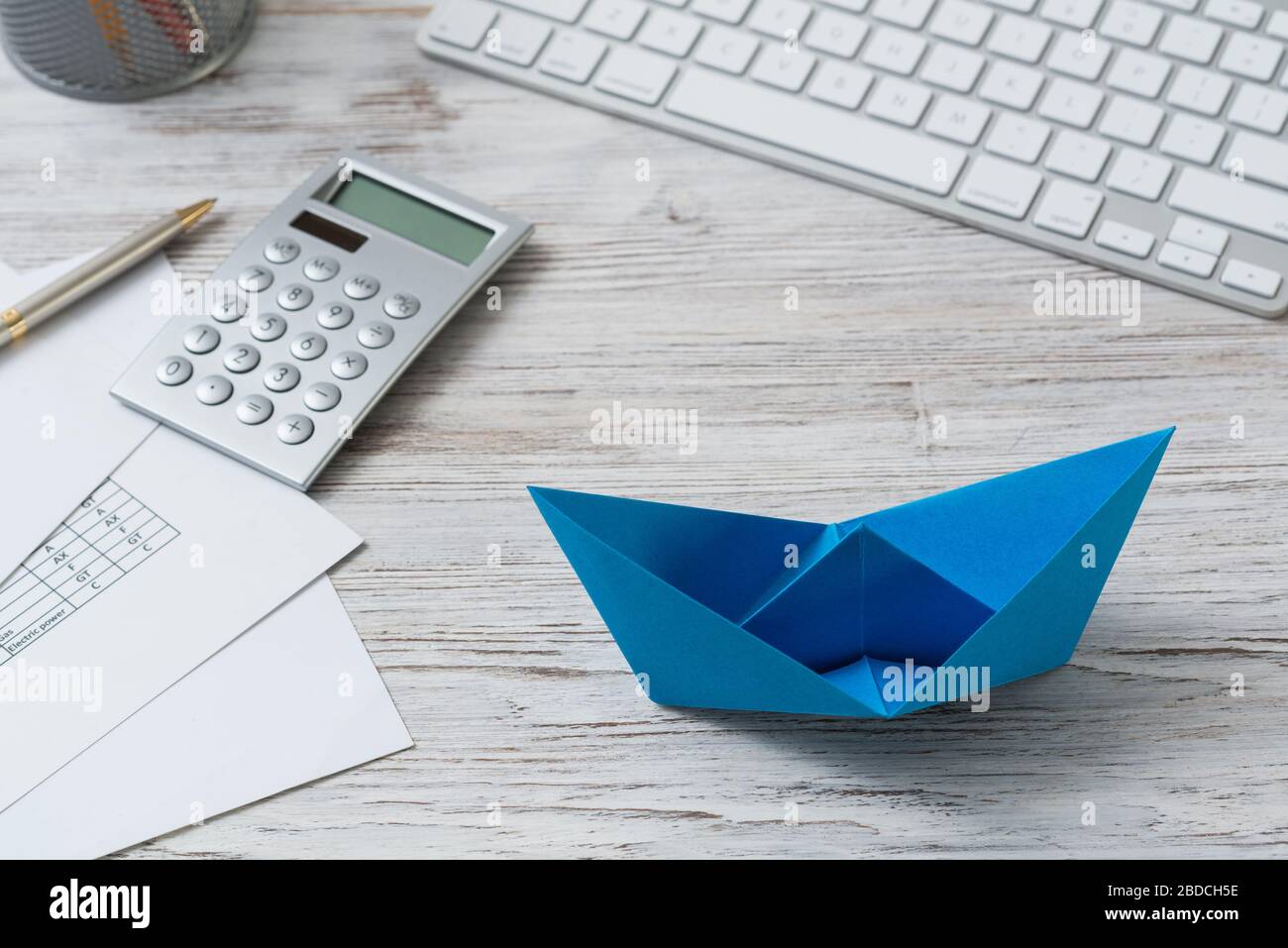 Modern office workspace with blue paper ship Stock Photo - Alamy