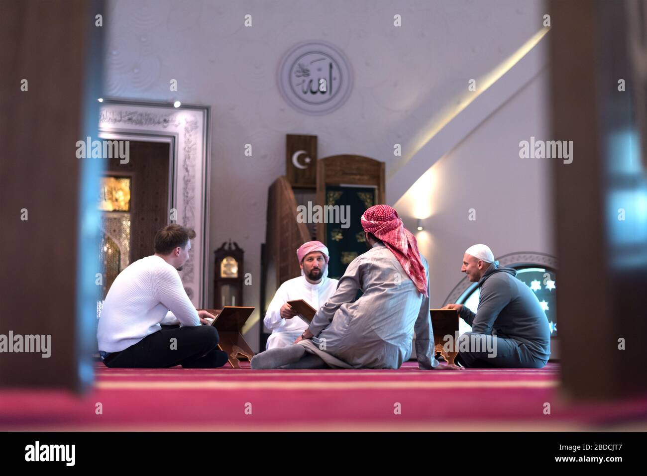 Group of muliethnic religious muslim young people praying and reading ...