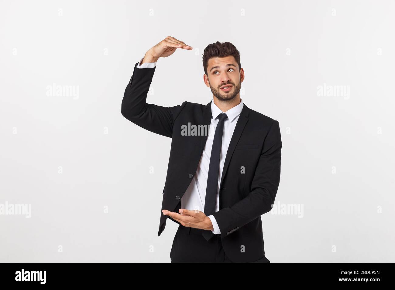 A man shows with his hands a large size on an isolated background Stock ...