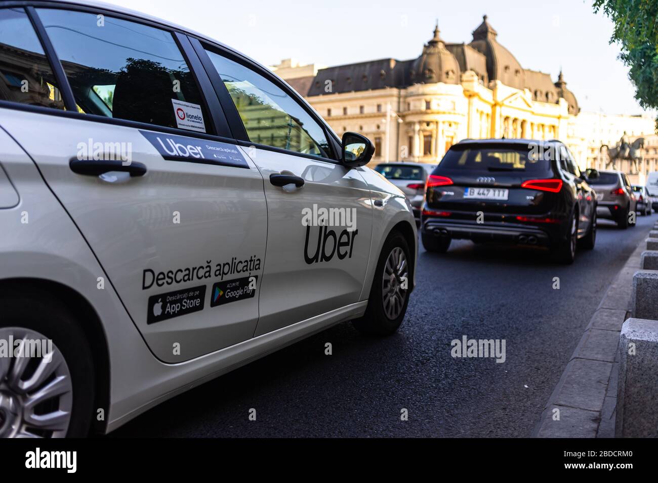 Uber car in traffic, modern city taxi service. Car pollution, traffic ...