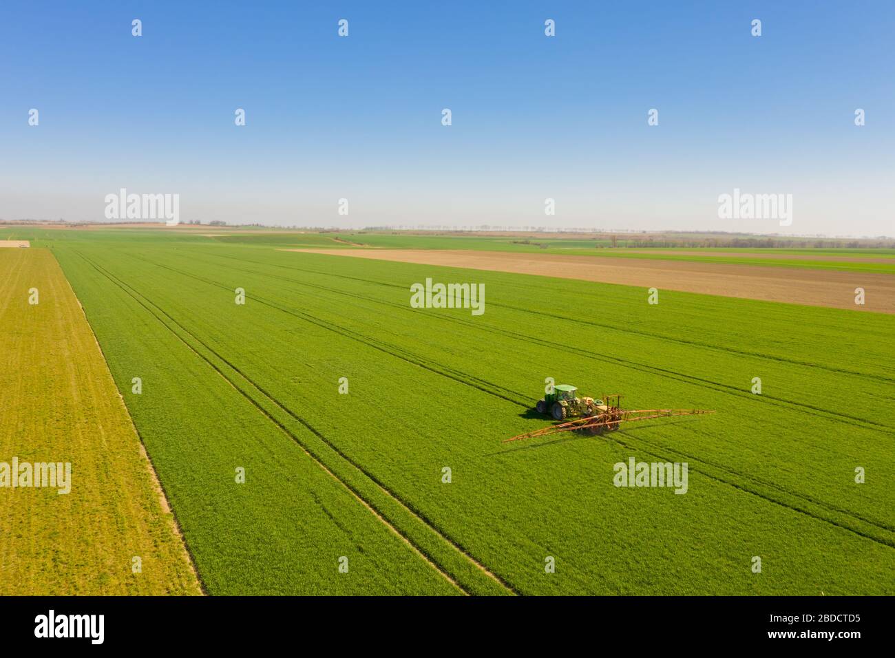 Agriculture Tractor Working in Field Stock Photo - Alamy
