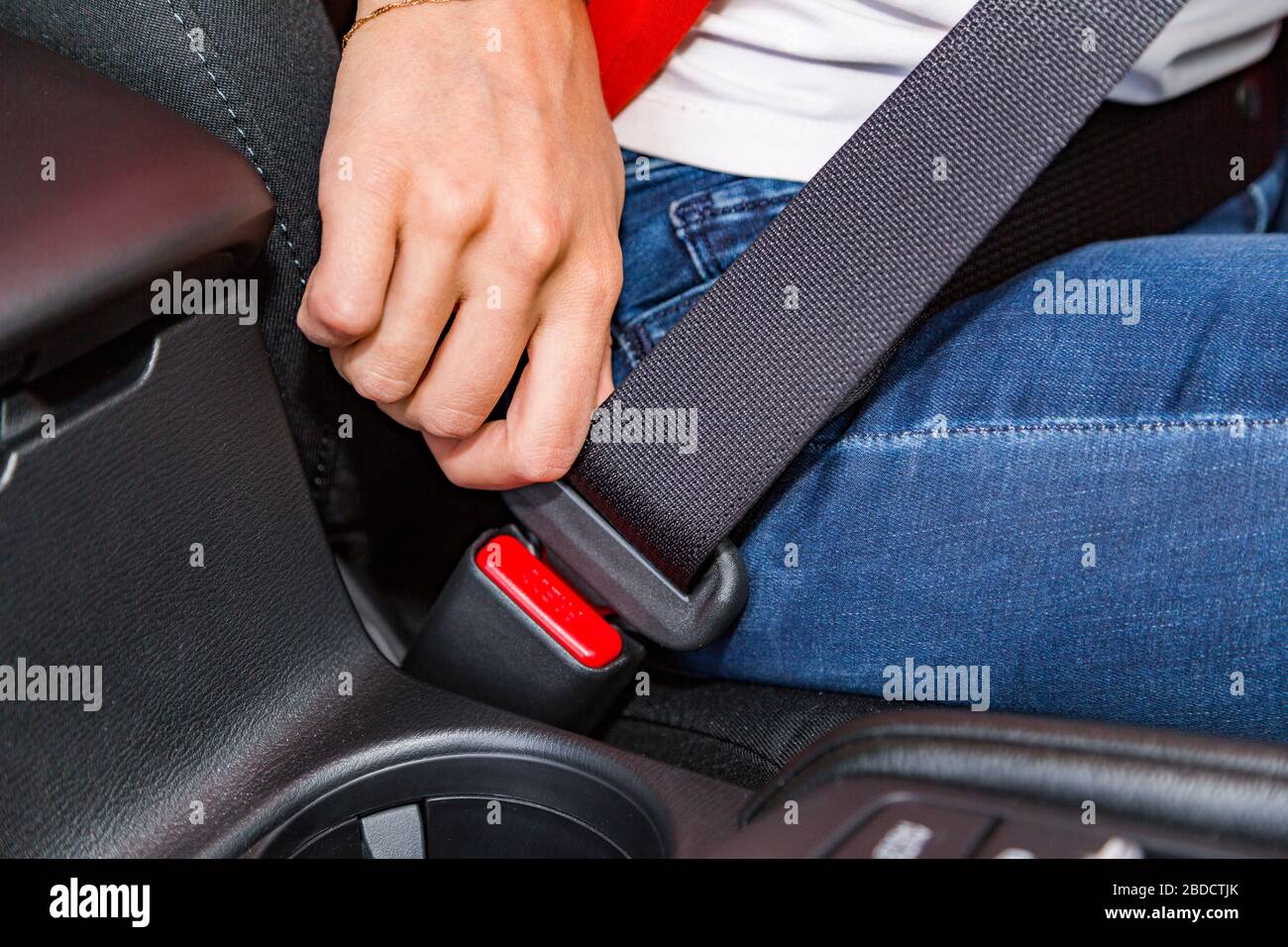 Close up female hand fasten seat belt in car Stock Photo - Alamy