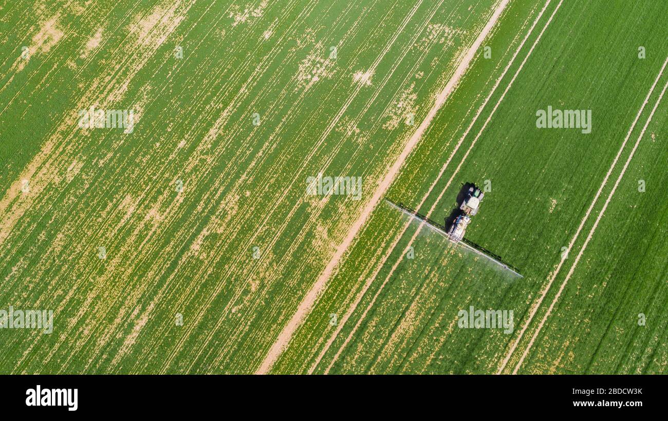 Agriculture Tractor Working in Field Stock Photo - Alamy