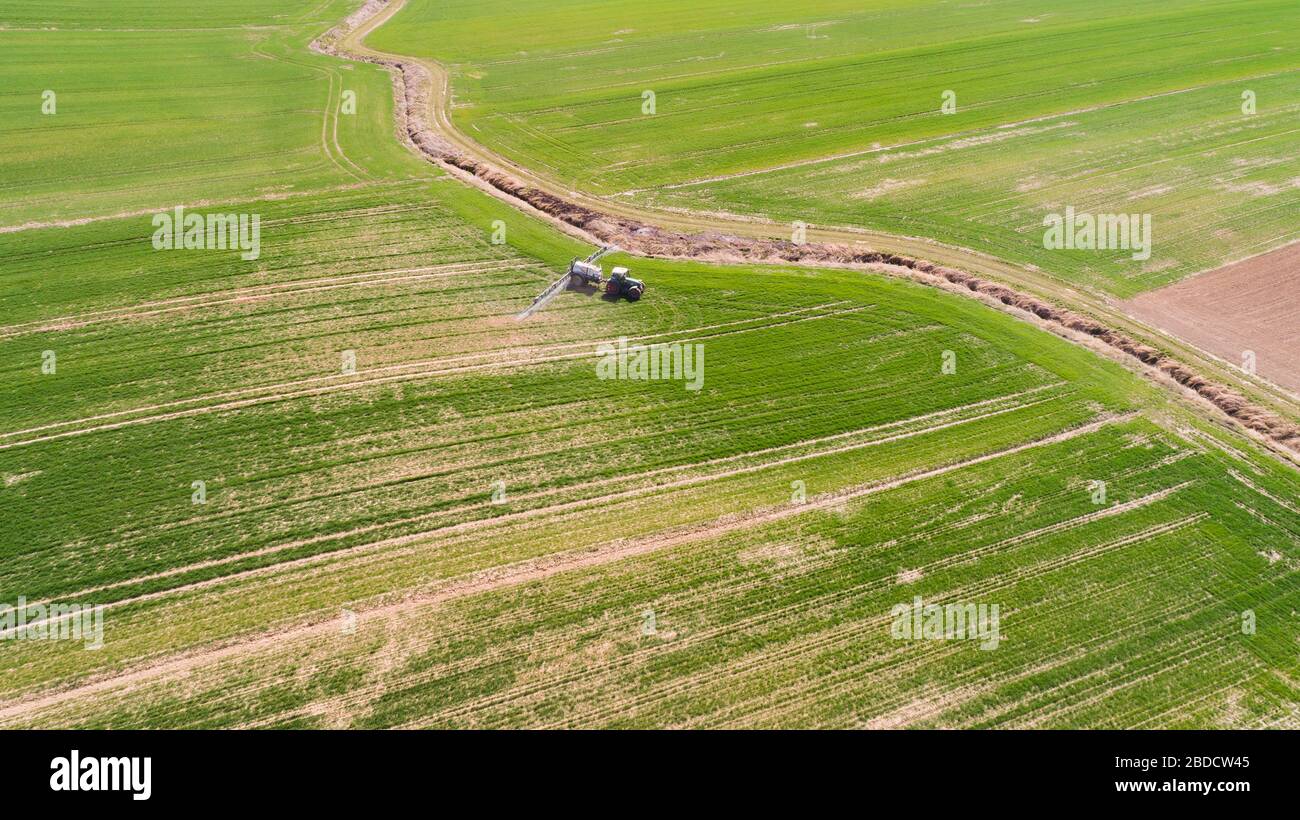Agriculture Tractor Working in Field Stock Photo - Alamy