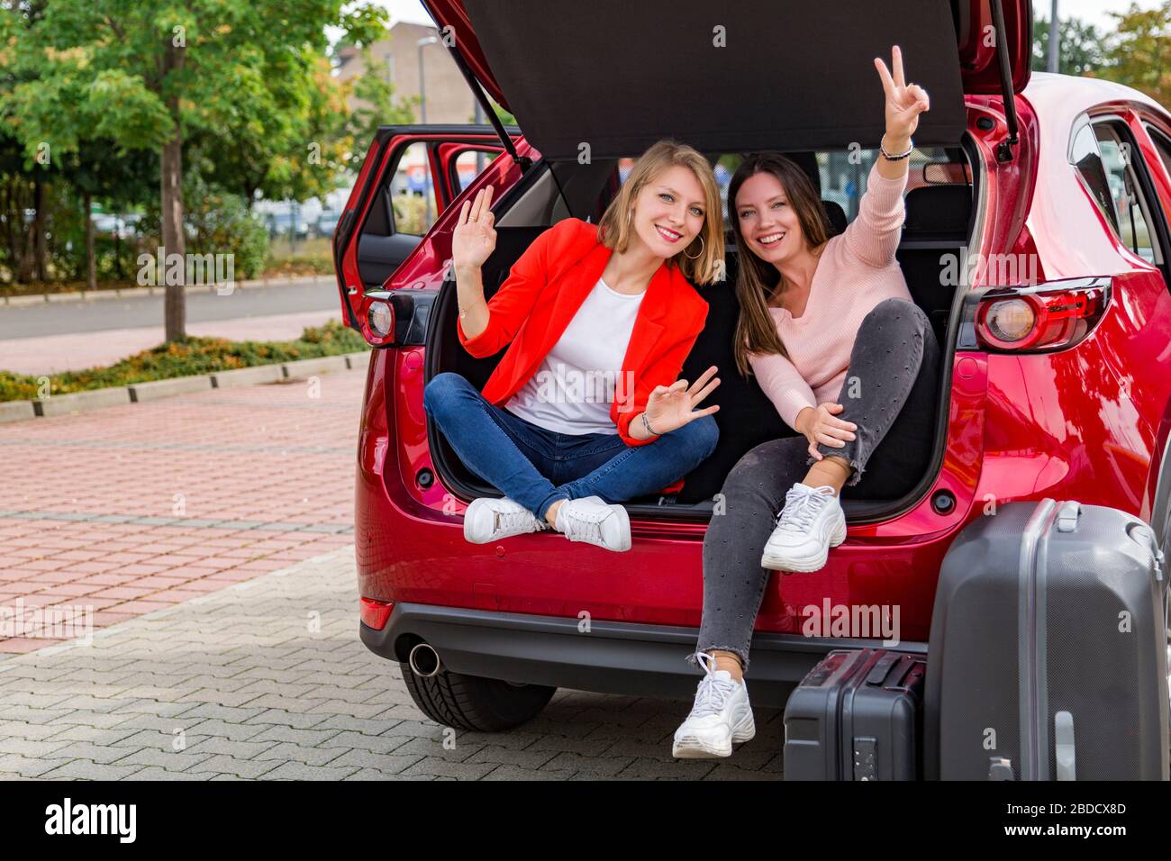 Two girls posing in car hi-res stock photography and images - Alamy
