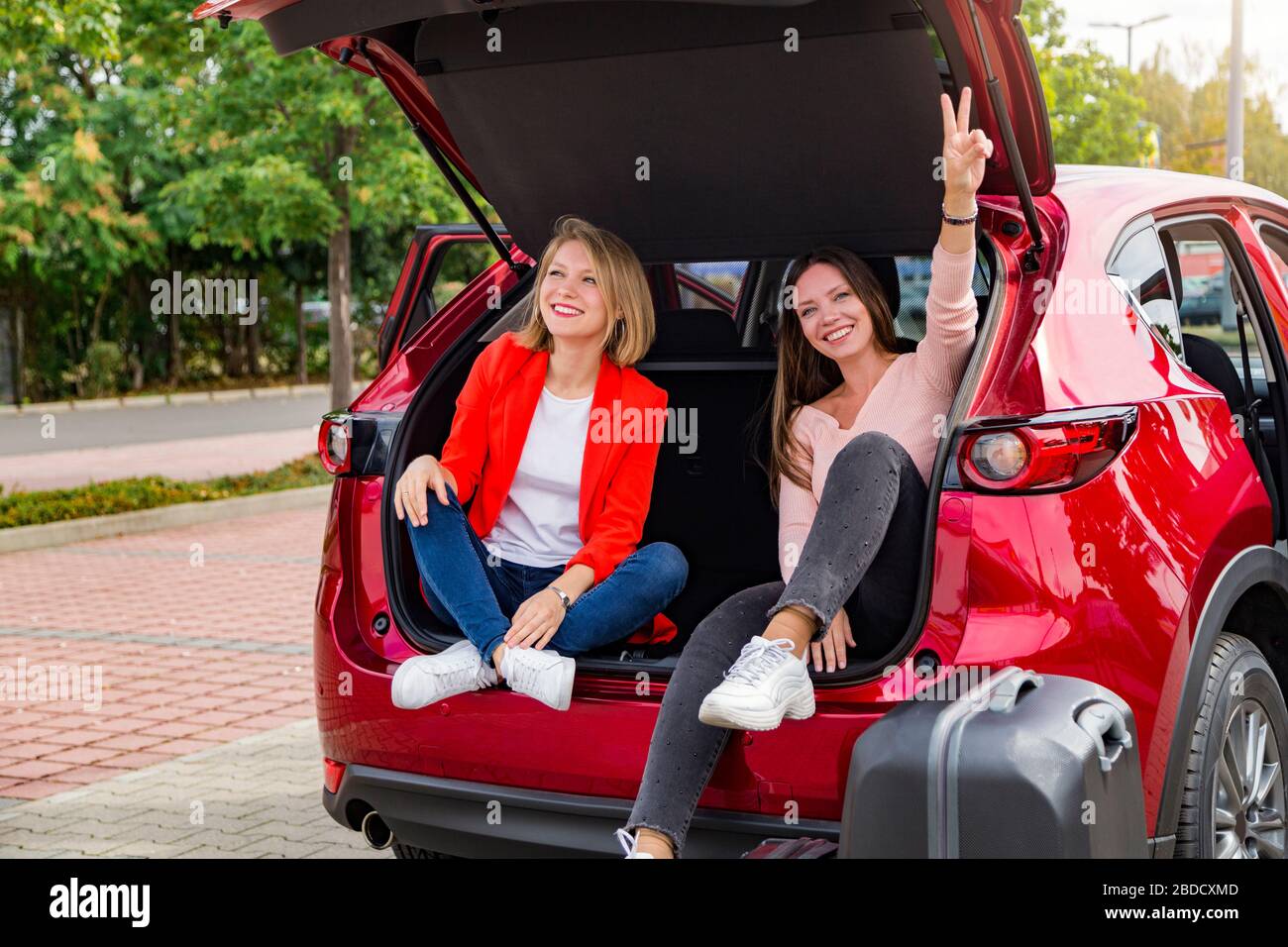 Two girls posing in car hi-res stock photography and images - Alamy