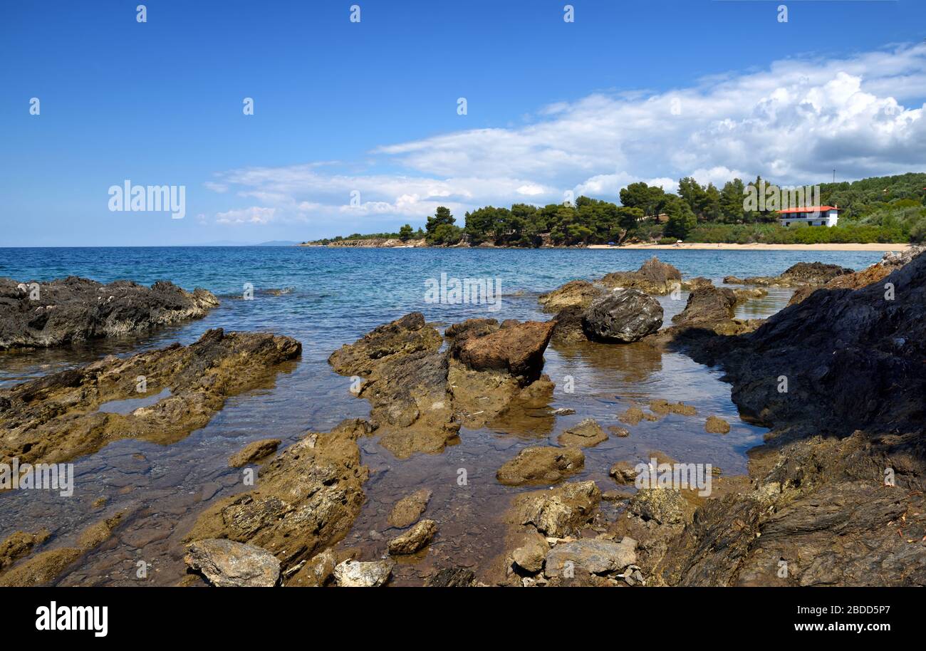 Beautiful seascape with stones and translucent blue water Stock Photo ...