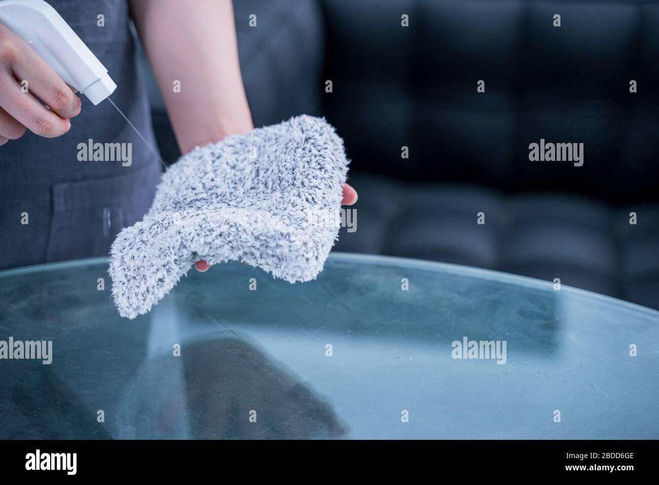 Woman cleaning glass table hi-res stock photography and images - Alamy