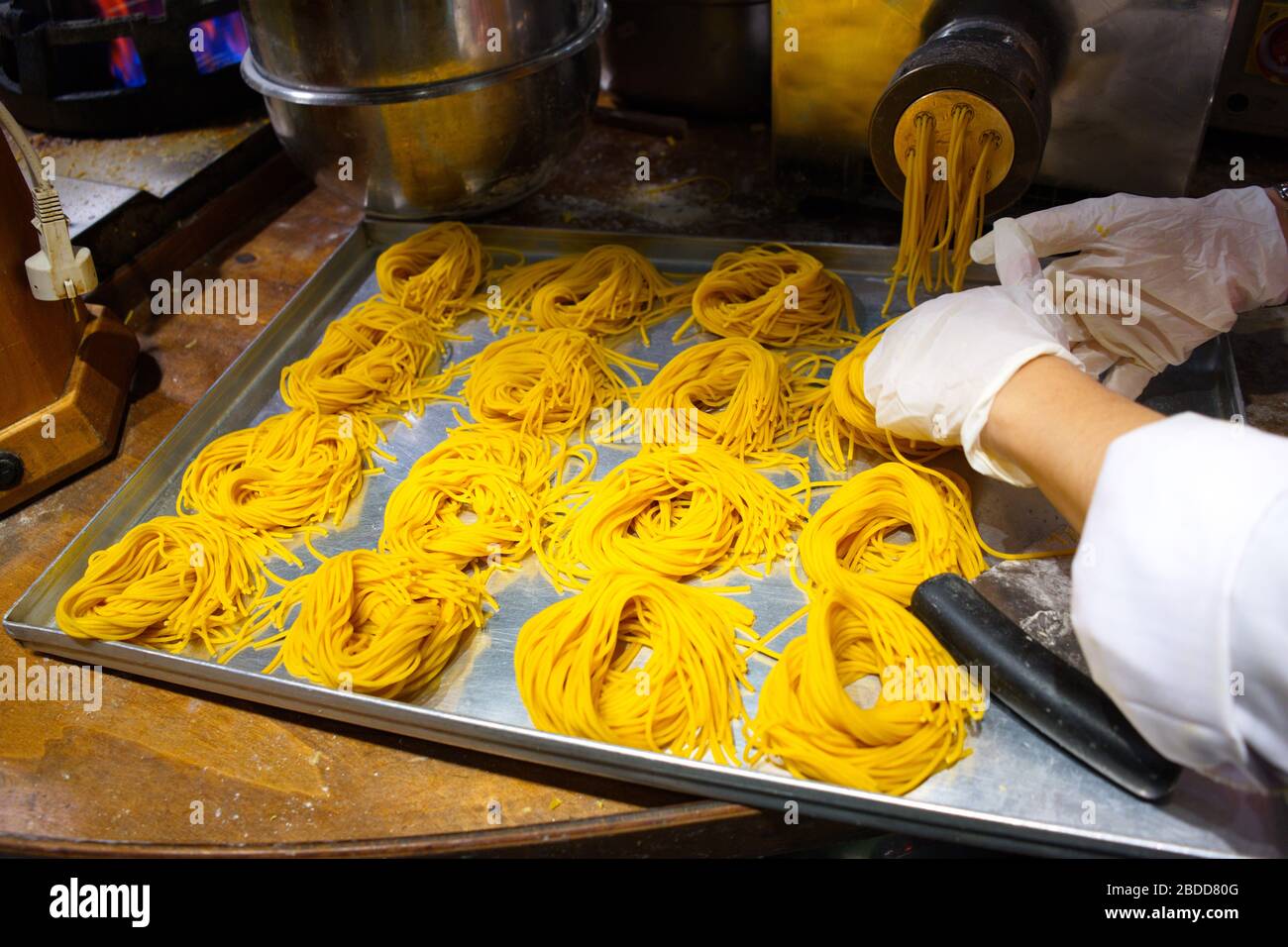making fresh organic macaroni. Spaghetti macaroni variety is made Stock ...