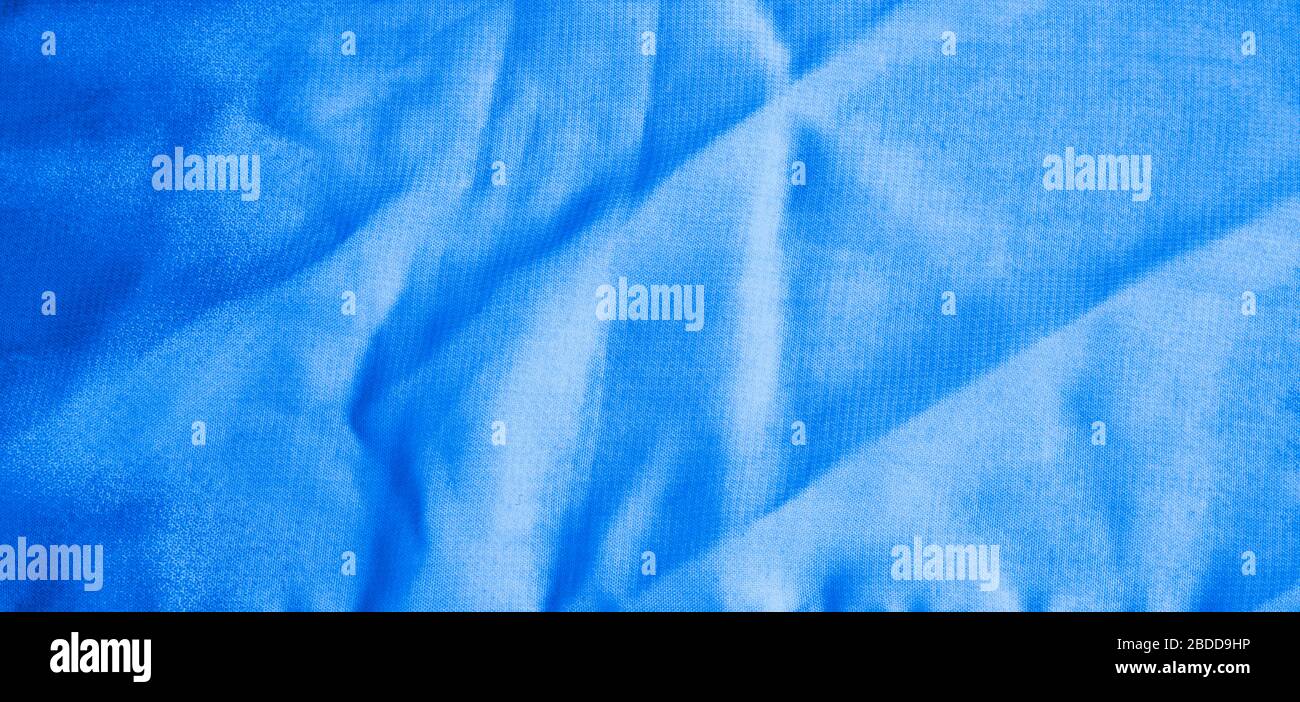Texture of classic blue Wrinkled Fabric. Trendy color of clothes. Close ...
