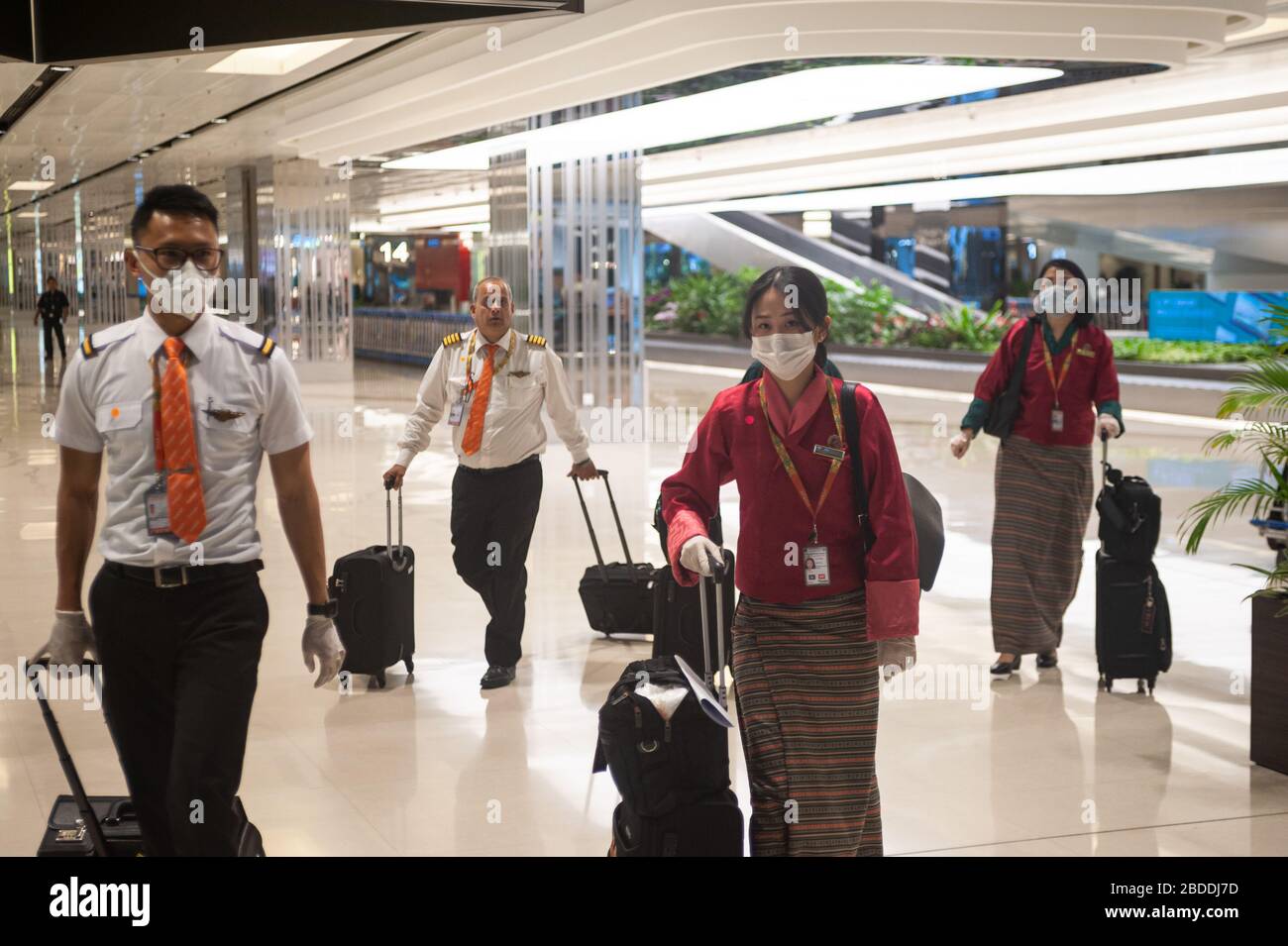 28.03.2020, Singapore, , Singapore - Pilots and flight attendants of Druk Air from Bhutan wear ...