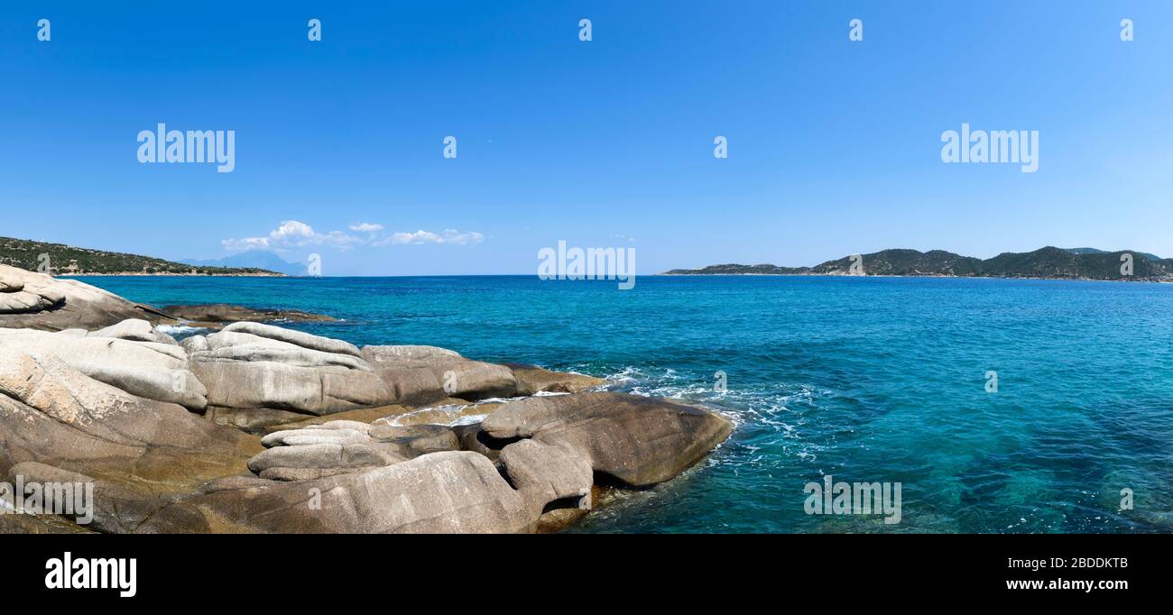 Beautiful seascape with stones and translucent blue water Stock Photo ...