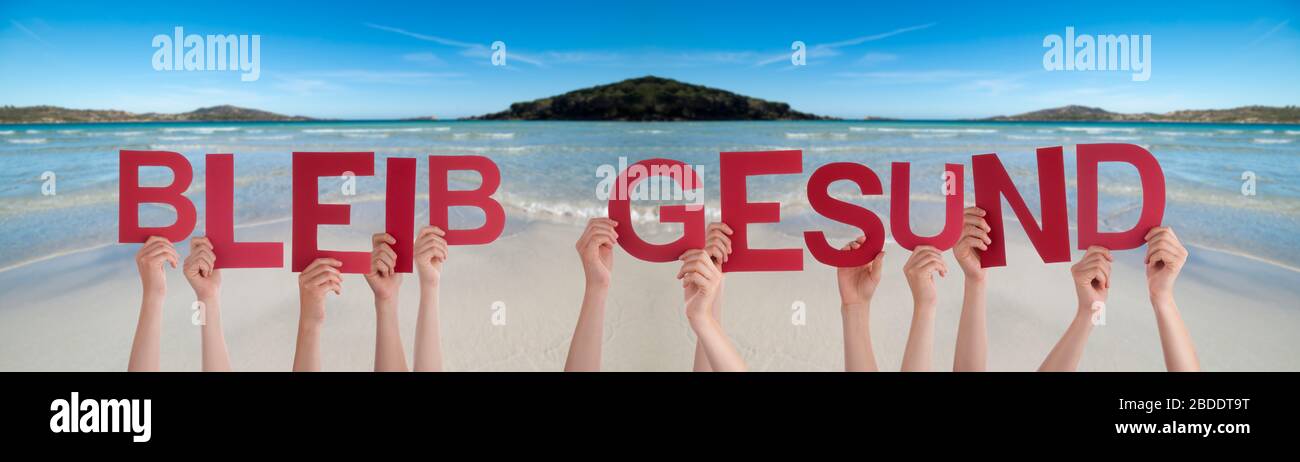 People Hands Holding Word Bleib Gesund Means Stay Healthy, Ocean ...