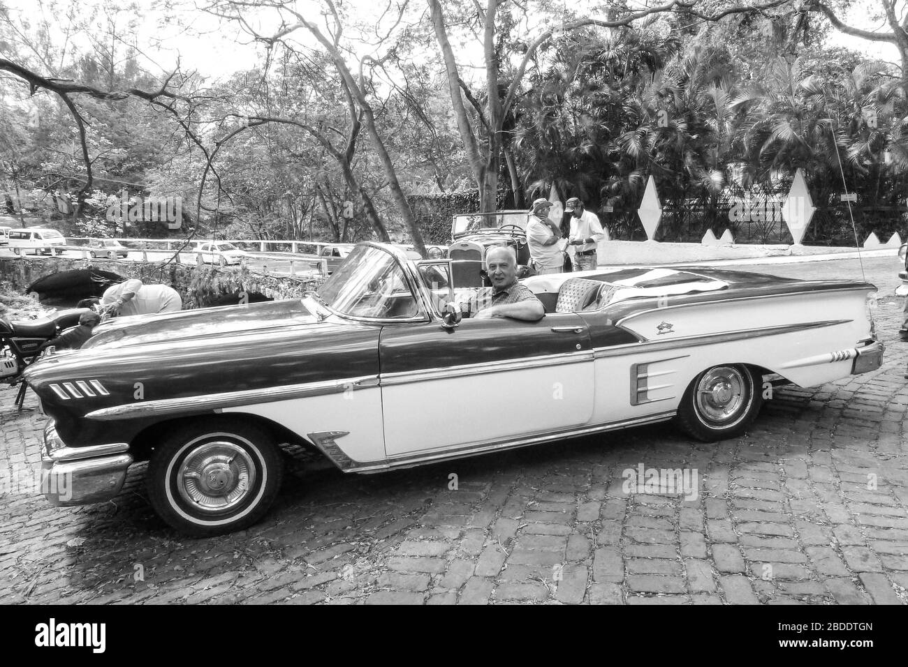 local man in old Classic American car in Havana Cuba wearing sun ...