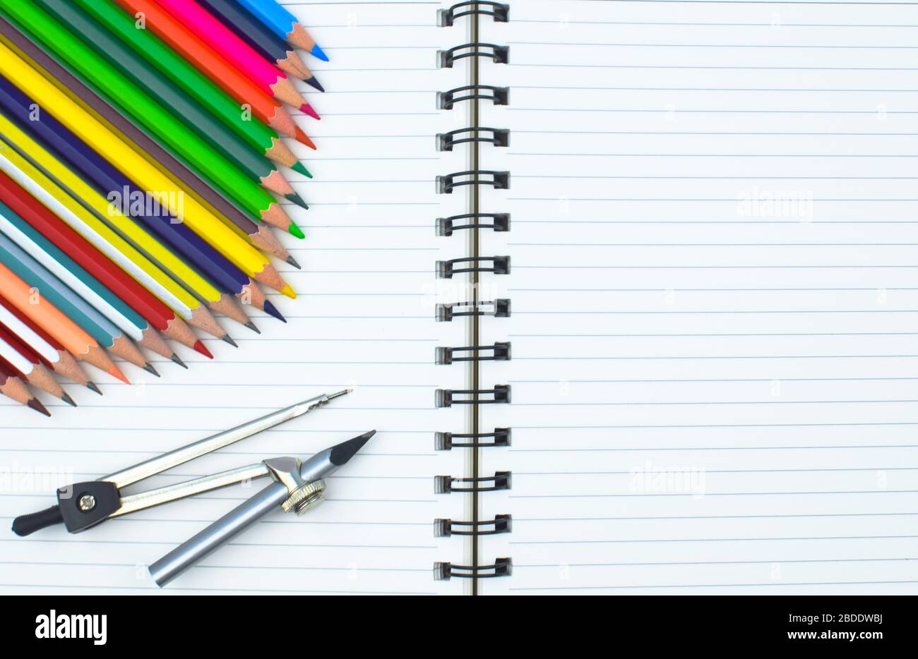 A pencil compass attached to a pencil along side a row of different ...