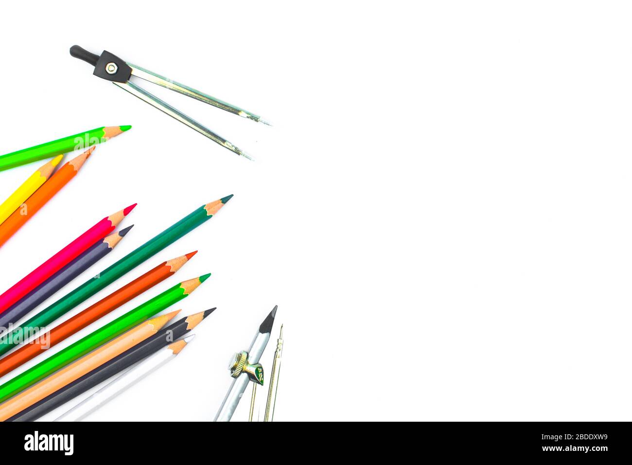 Some different colored wood pencil crayon and two pencil compass while ...