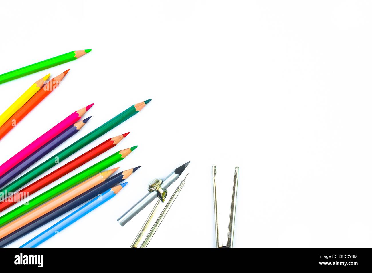 Some various colored wood pencil crayon and two pencil compass while ...