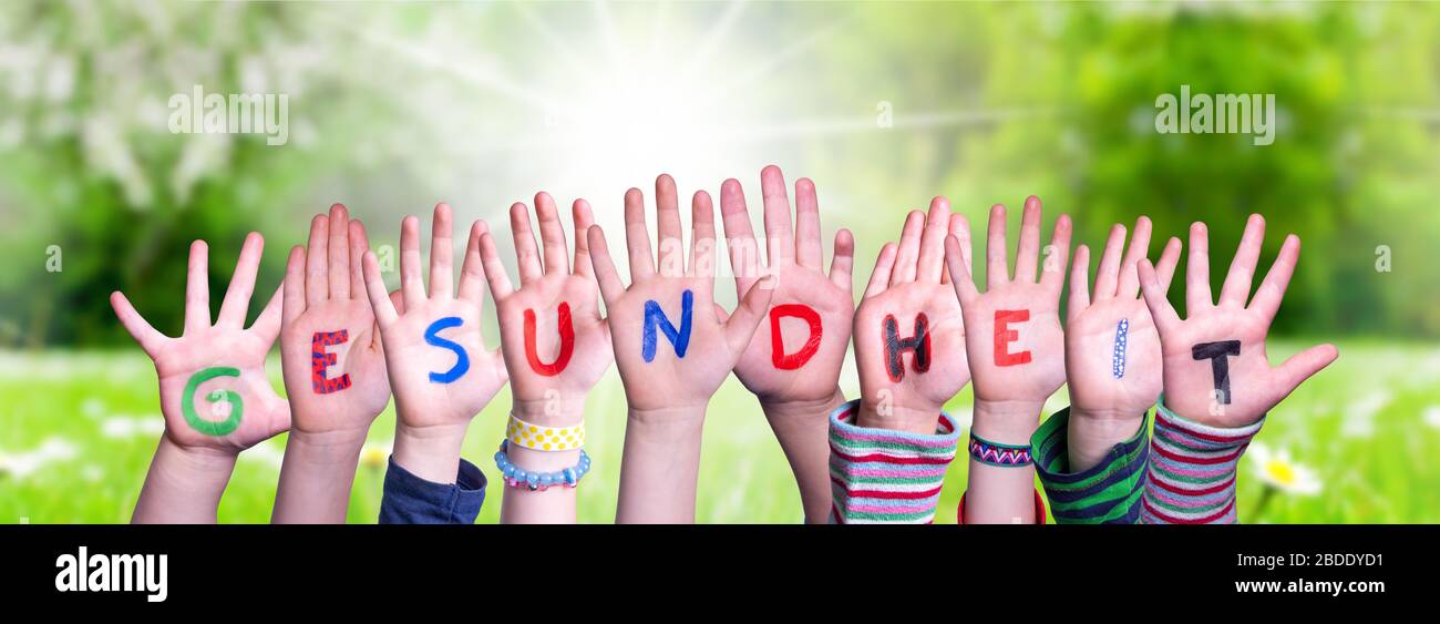 Kids Hands Holding Word Gesundheit Means Health, Grass Meadow Stock ...