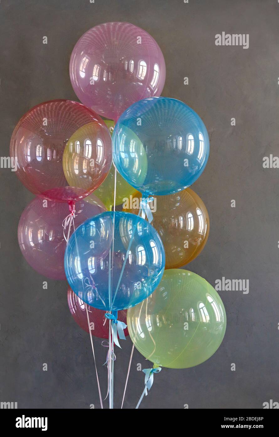 Big colorful balloons on the grey background Stock Photo - Alamy