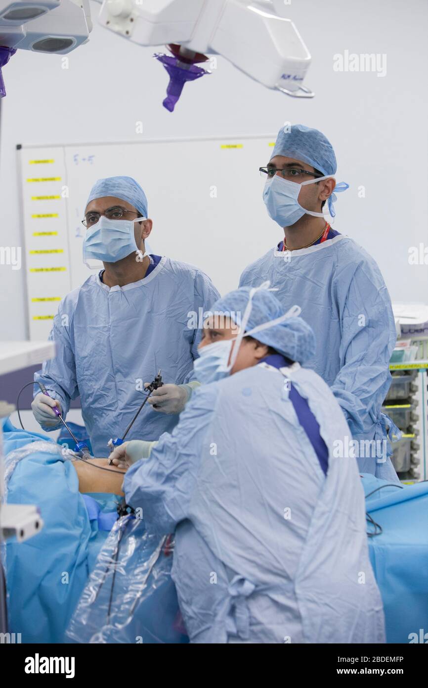 Surgeons and nurses perform stomach laparascopic surgery in an NHS ...