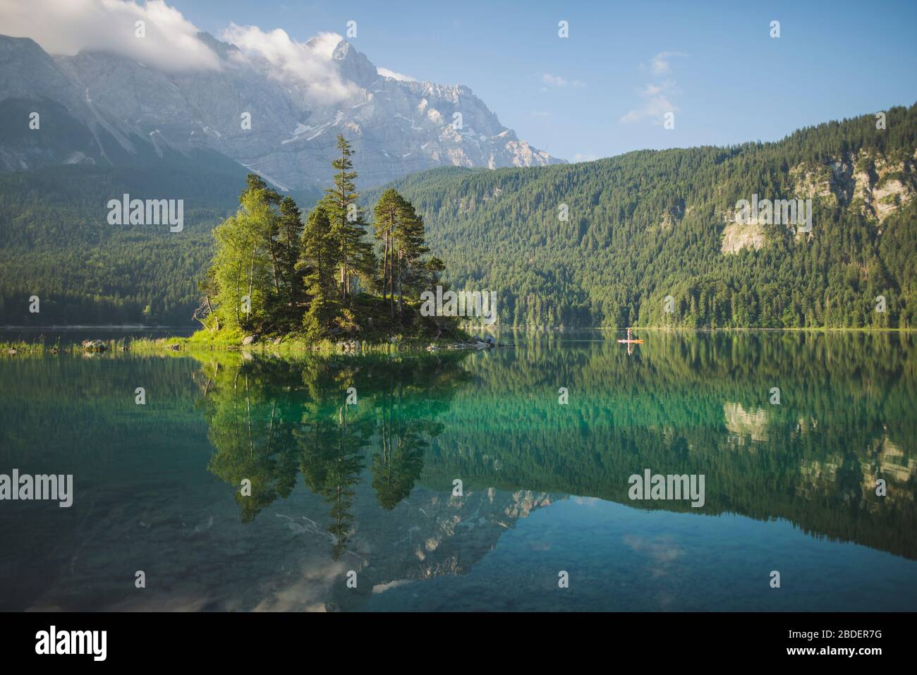 Germany, Bavaria, Eibsee, Distant view of woman paddleboarding on the ...