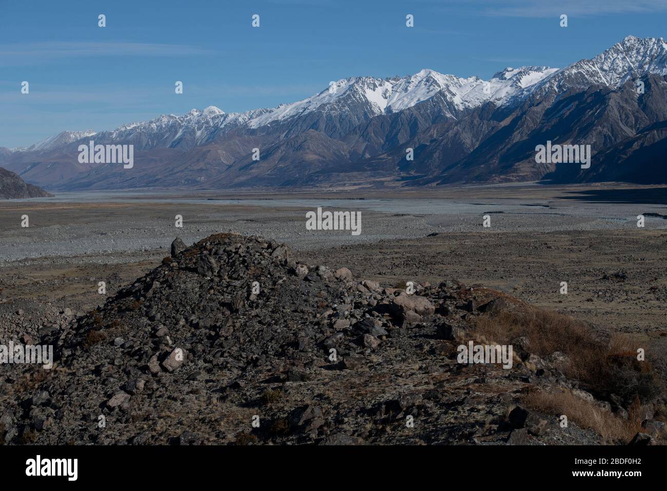View across outwash plain with snow-capped mountains in background ...