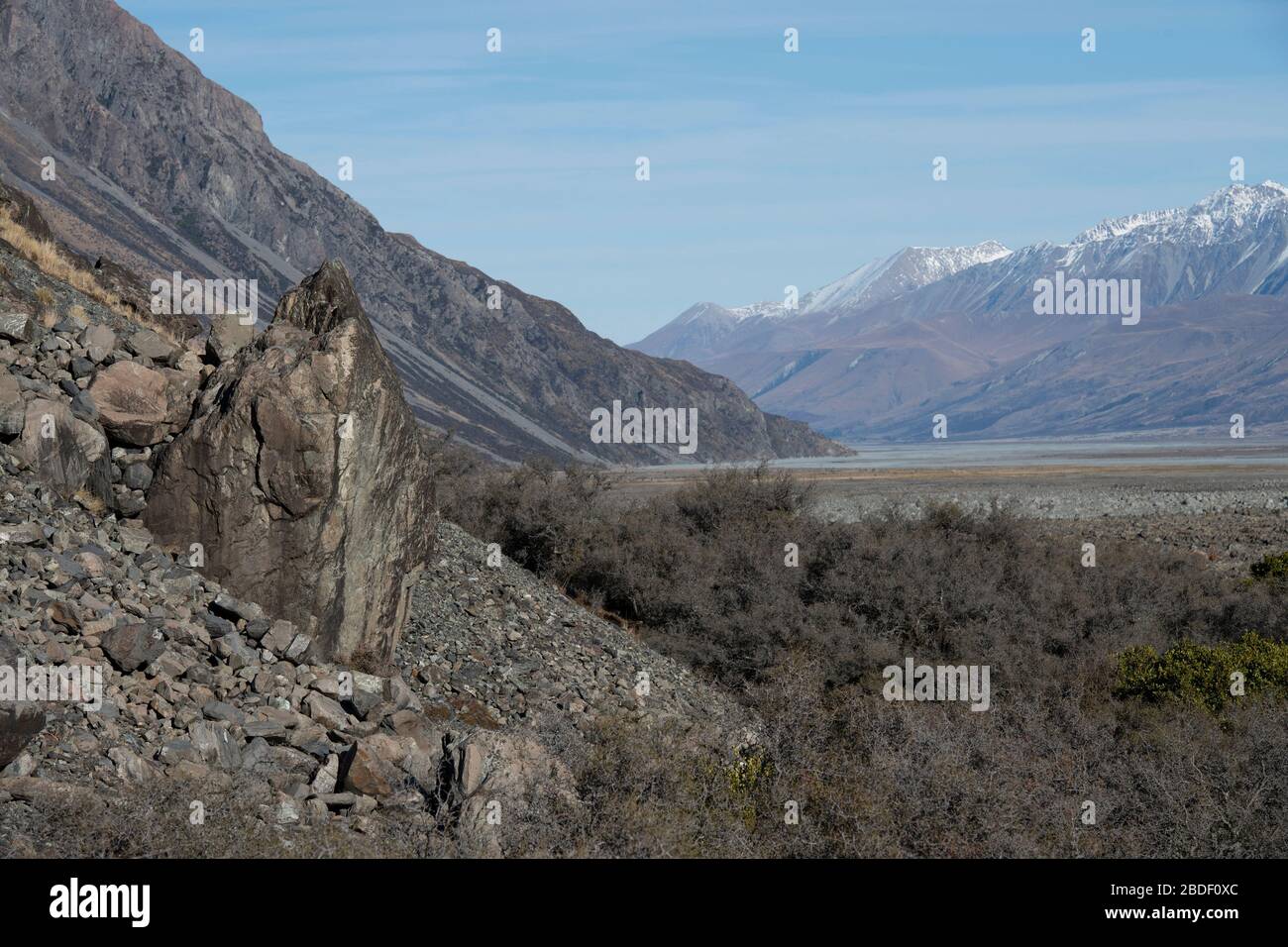 View across outwash plain with snow-capped mountains in background ...