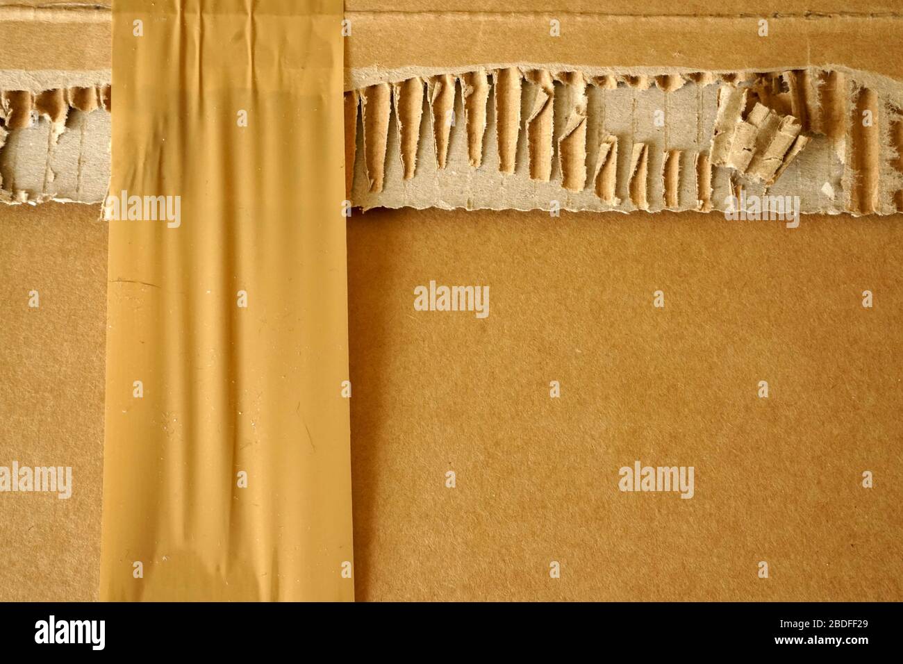 Sheets of brown corrugated cardboard with tape as a background. Details ...