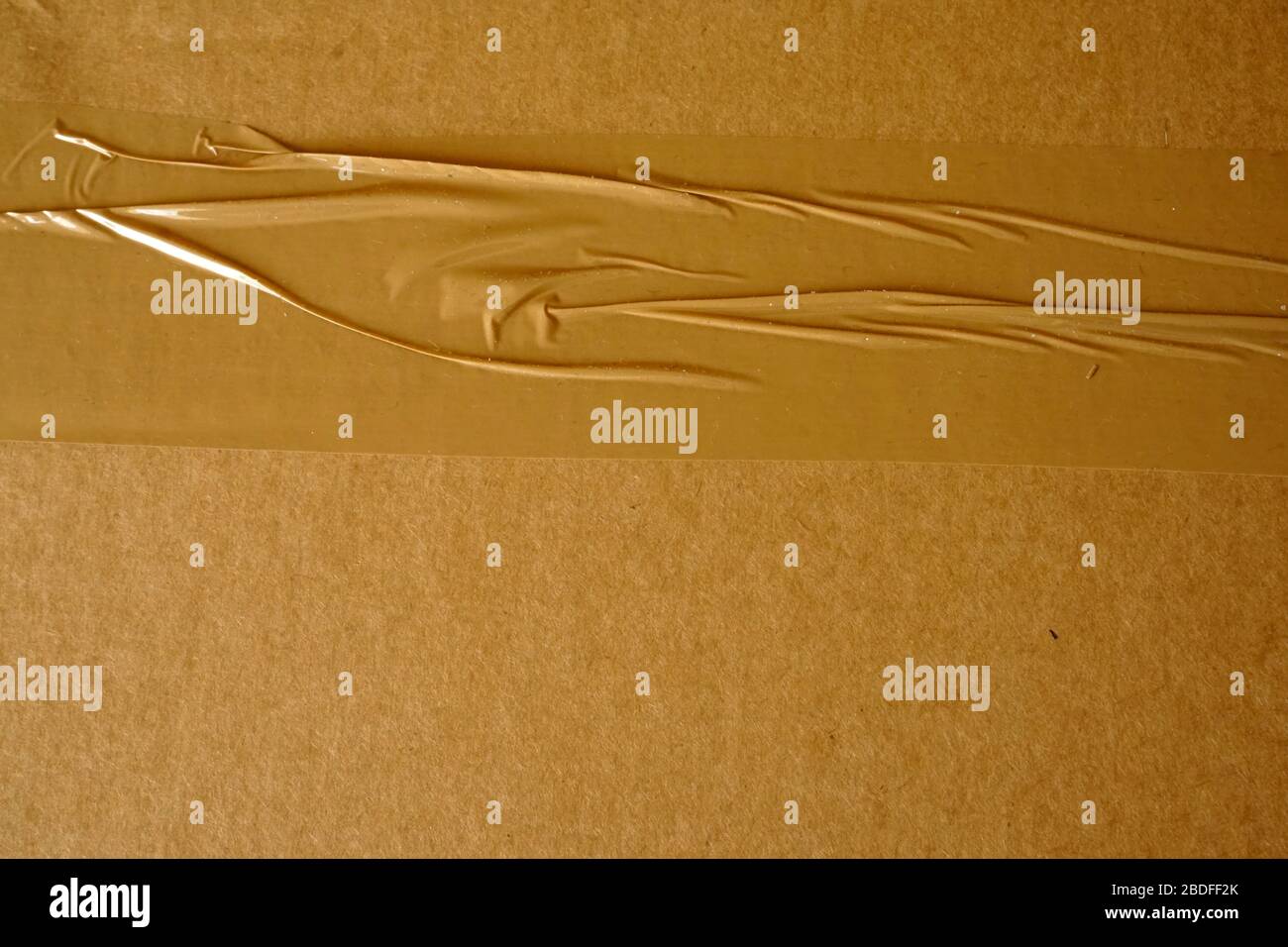 Sheets of brown corrugated cardboard with tape as a background. Details ...
