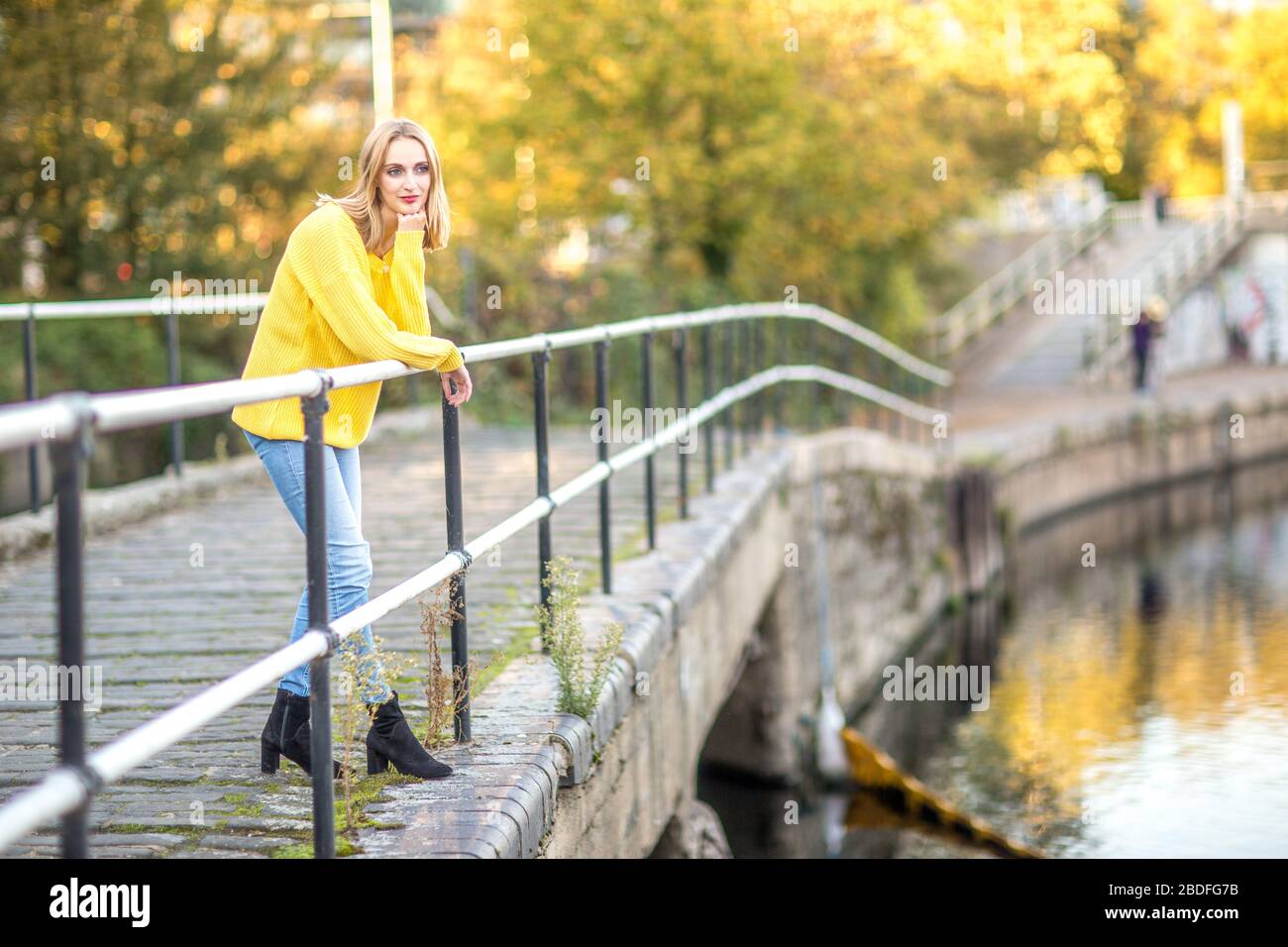 young woman standing by the river thinking Stock Photo - Alamy