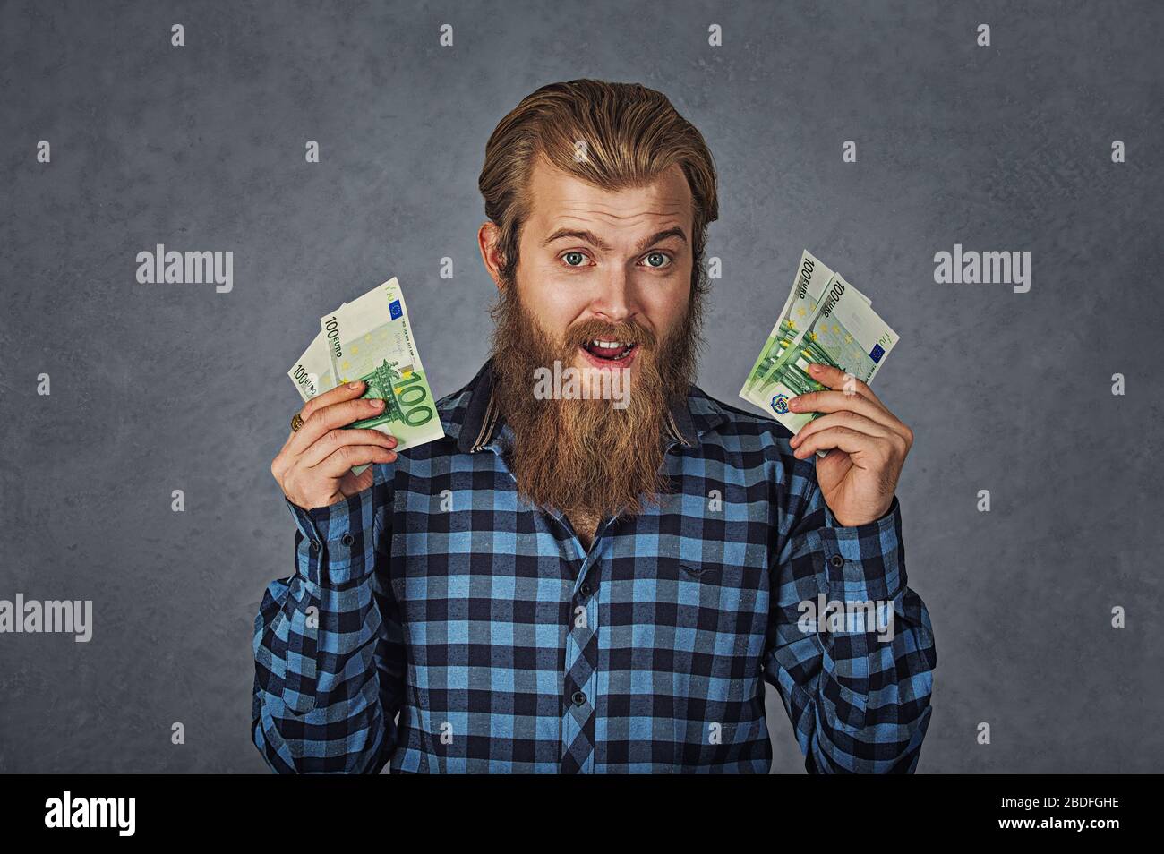 Portrait happy young man with money euro banknotes ecstatic celebrates ...