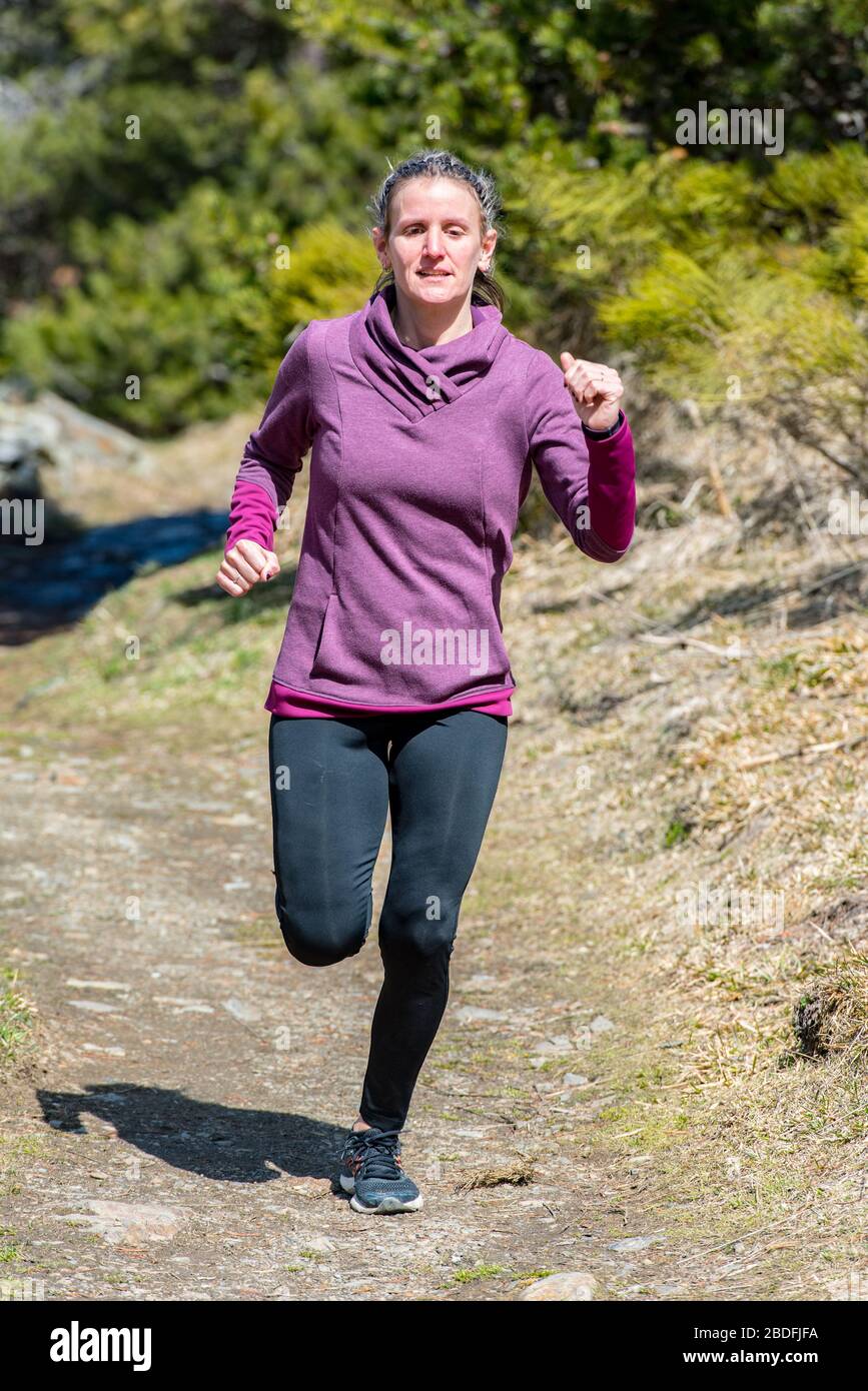 Young woman running up the hill. Trial run Stock Photo - Alamy