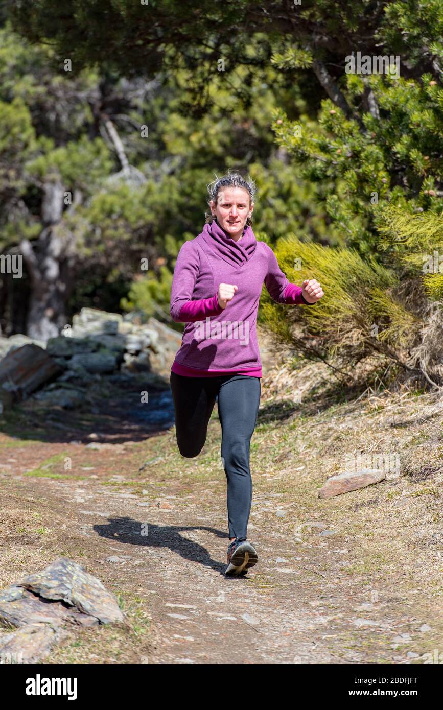 Young woman running up the hill. Trial run Stock Photo - Alamy