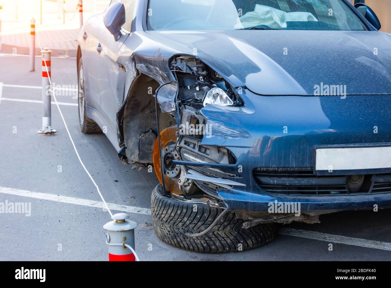 Broken front wheel and wing of a passenger car in a parking lot Stock ...